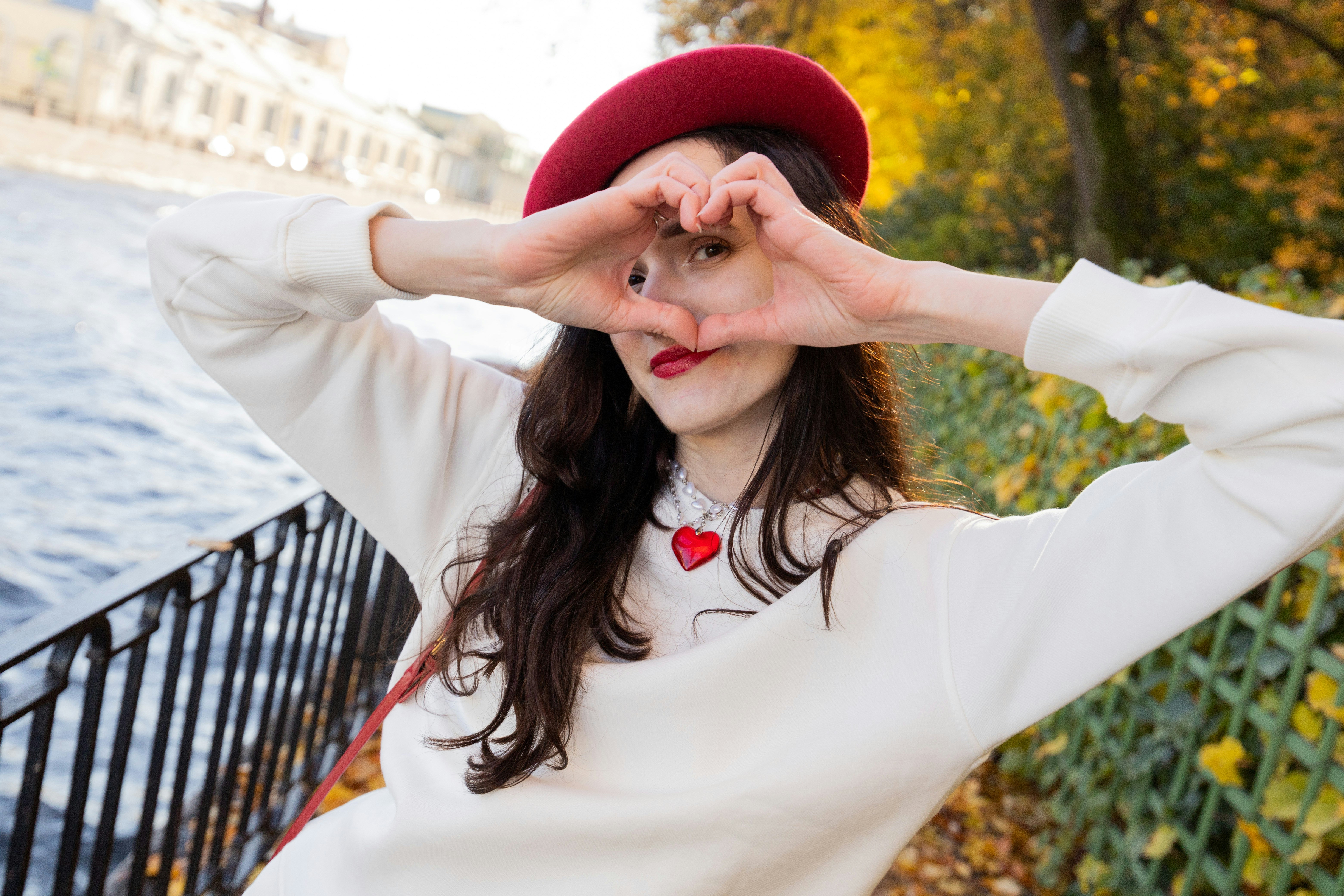 Heart-Shaped Glimpse: A Playful Portrait at the Waterfront