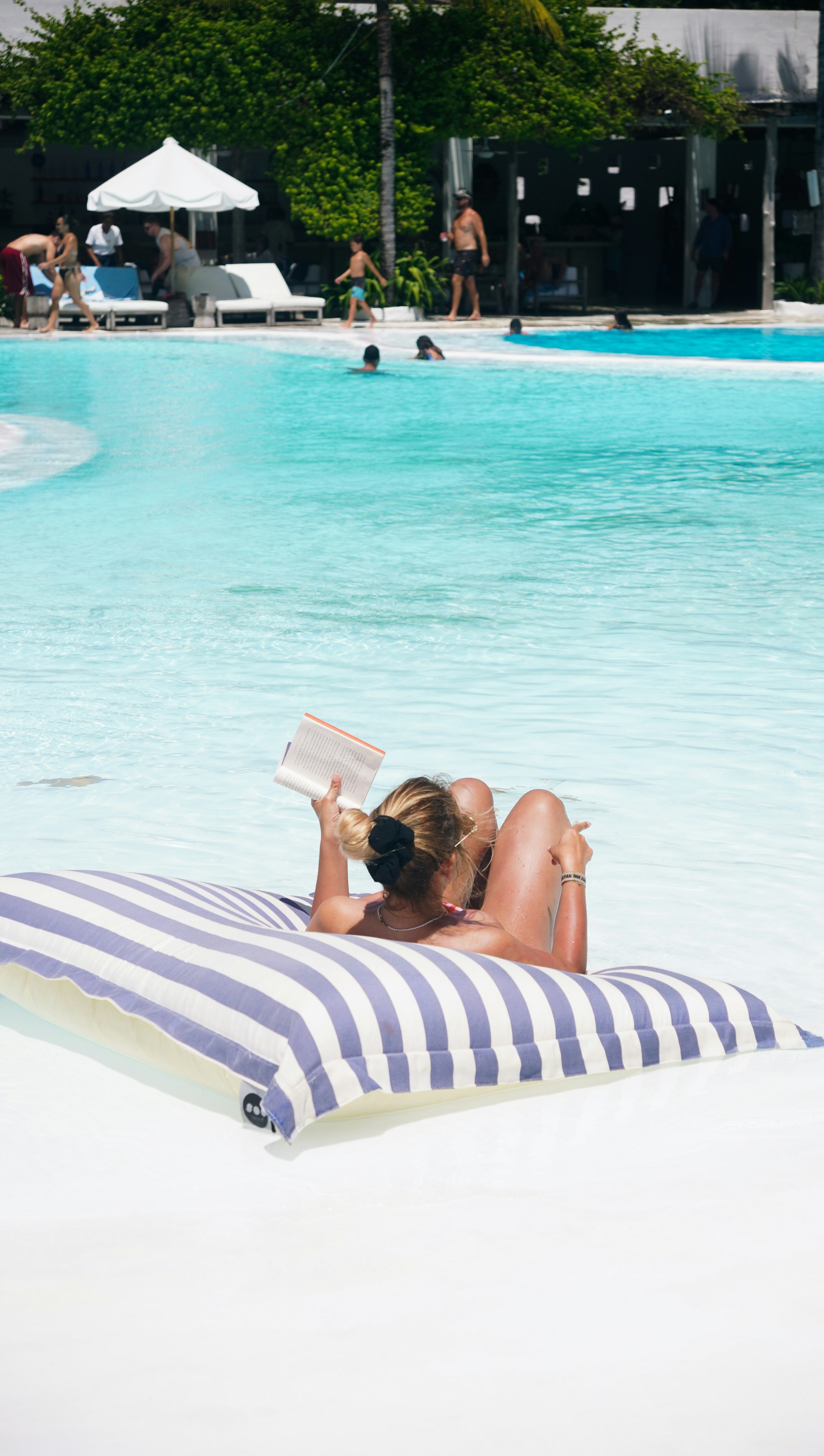 Sunlit Retreat: A Sunbather Delights on a Striped Pillow