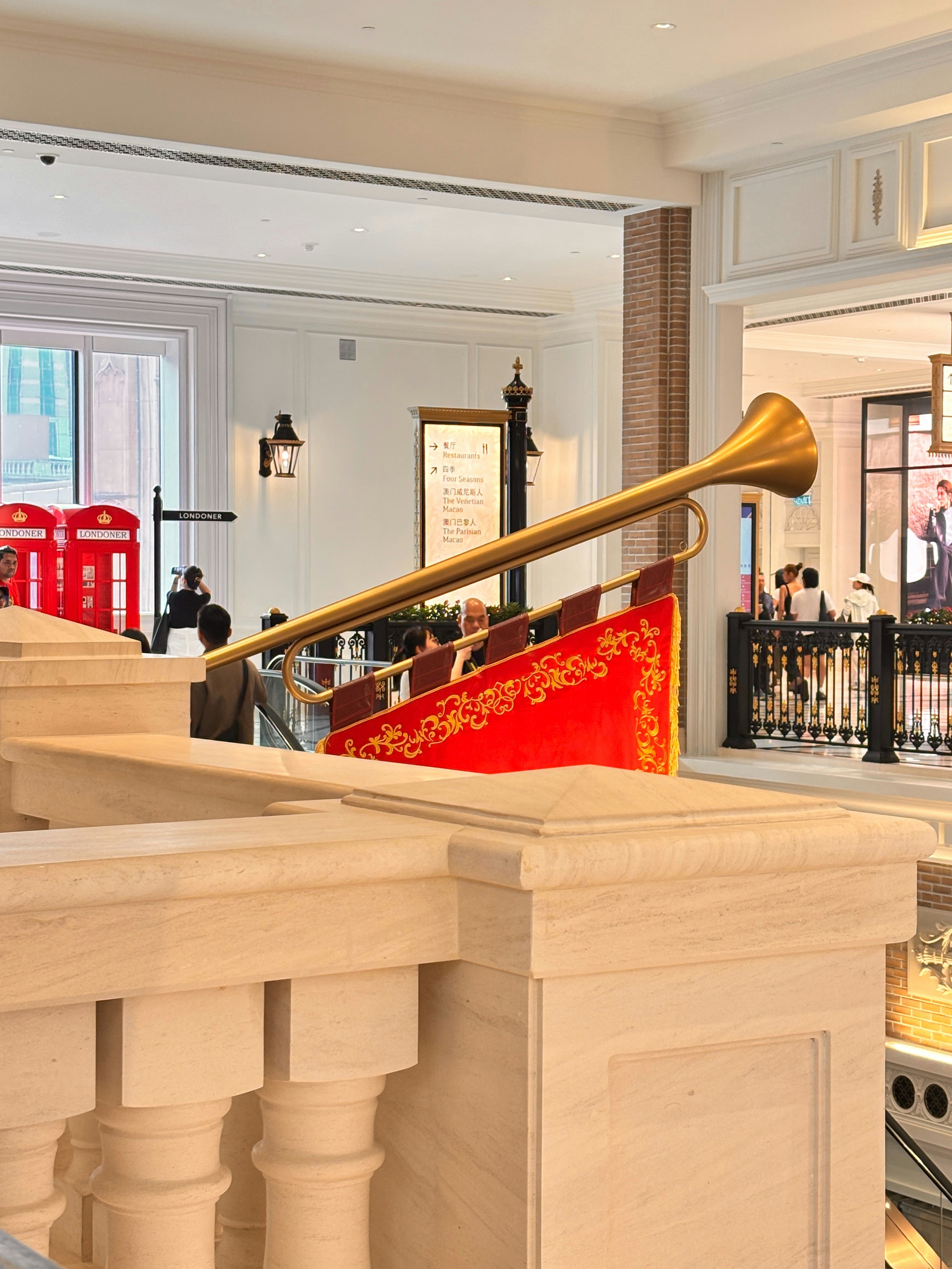 A Gentle Giant’s Horn Over a Grand Red Stair