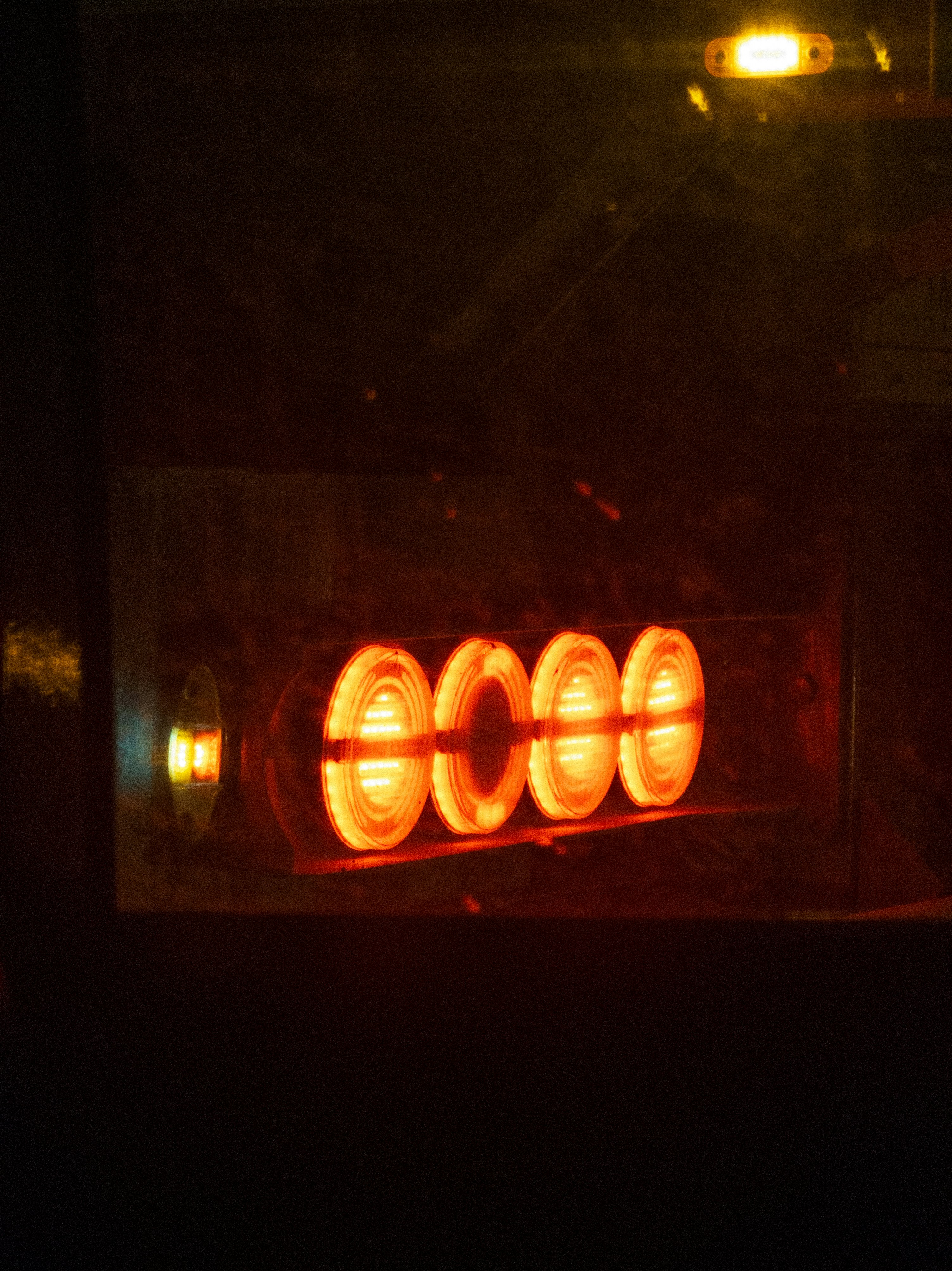 Glowing Red Orbs in a Dark Enclosure
