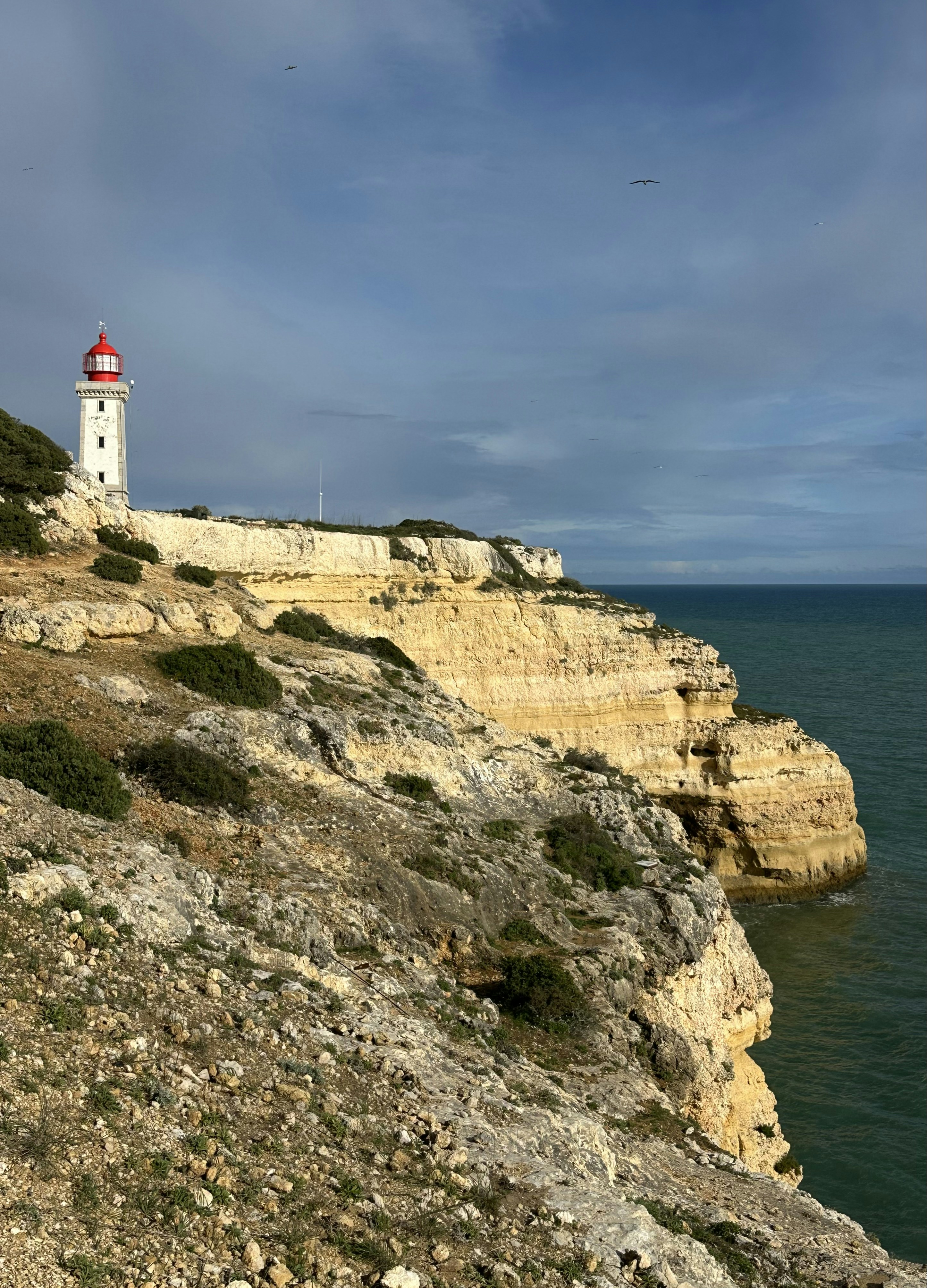 Lighthouse Perched on Coastal Cliffs at Dusk