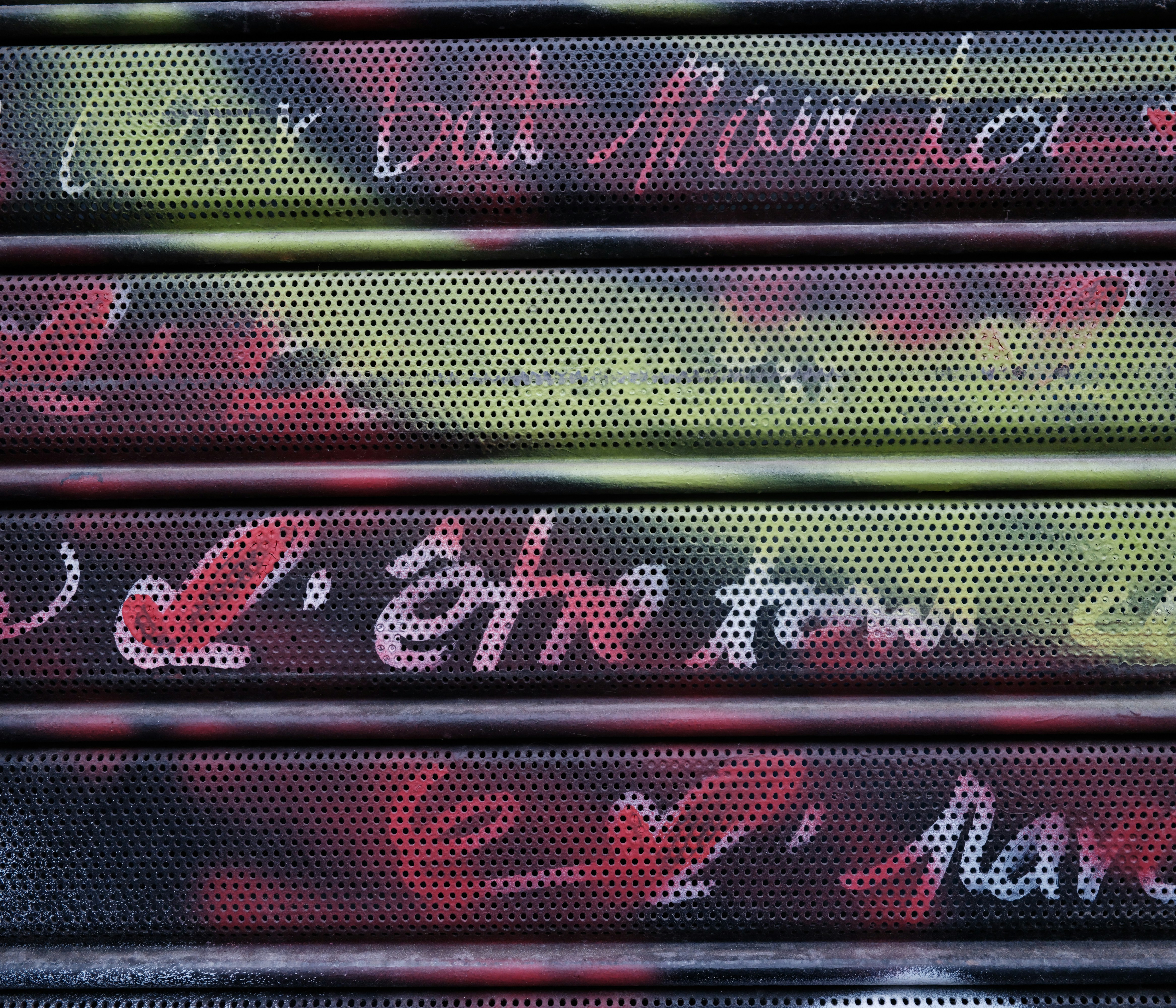 Graffiti Through Latticed Metal Blinds