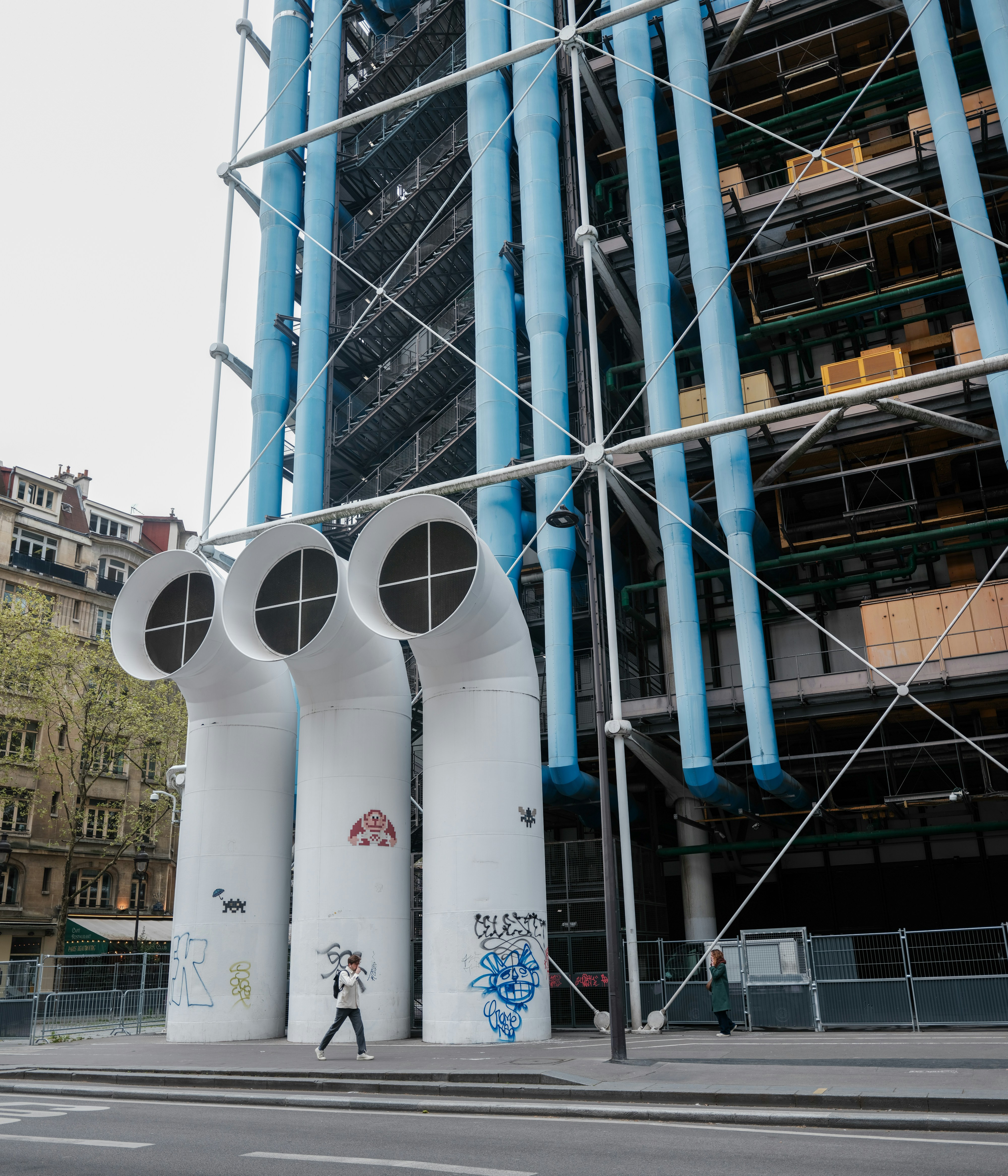 Industrial Sculptures: A Cityscape Confronted by Blue Trusses