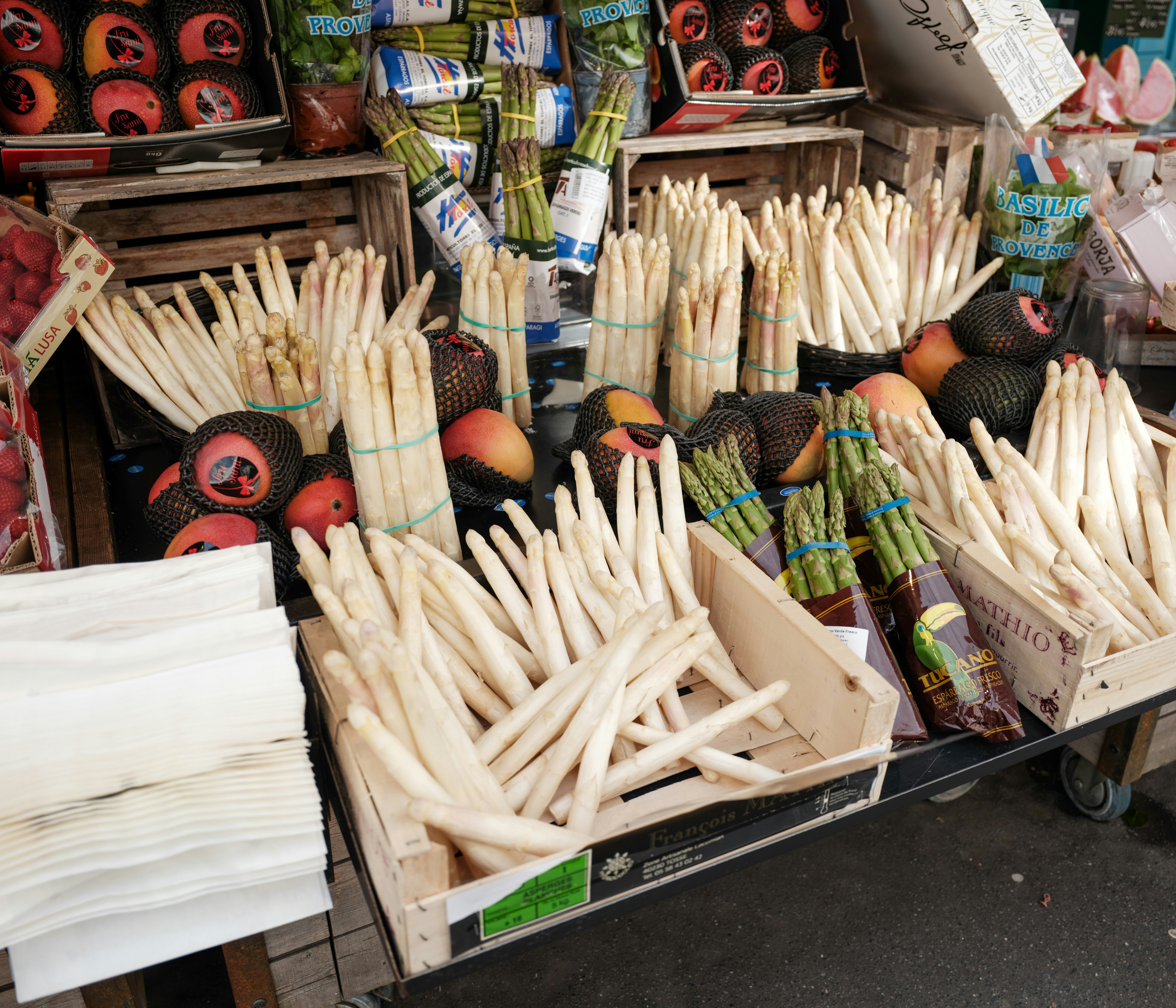 White asparagus and gourds at a crowded market stall