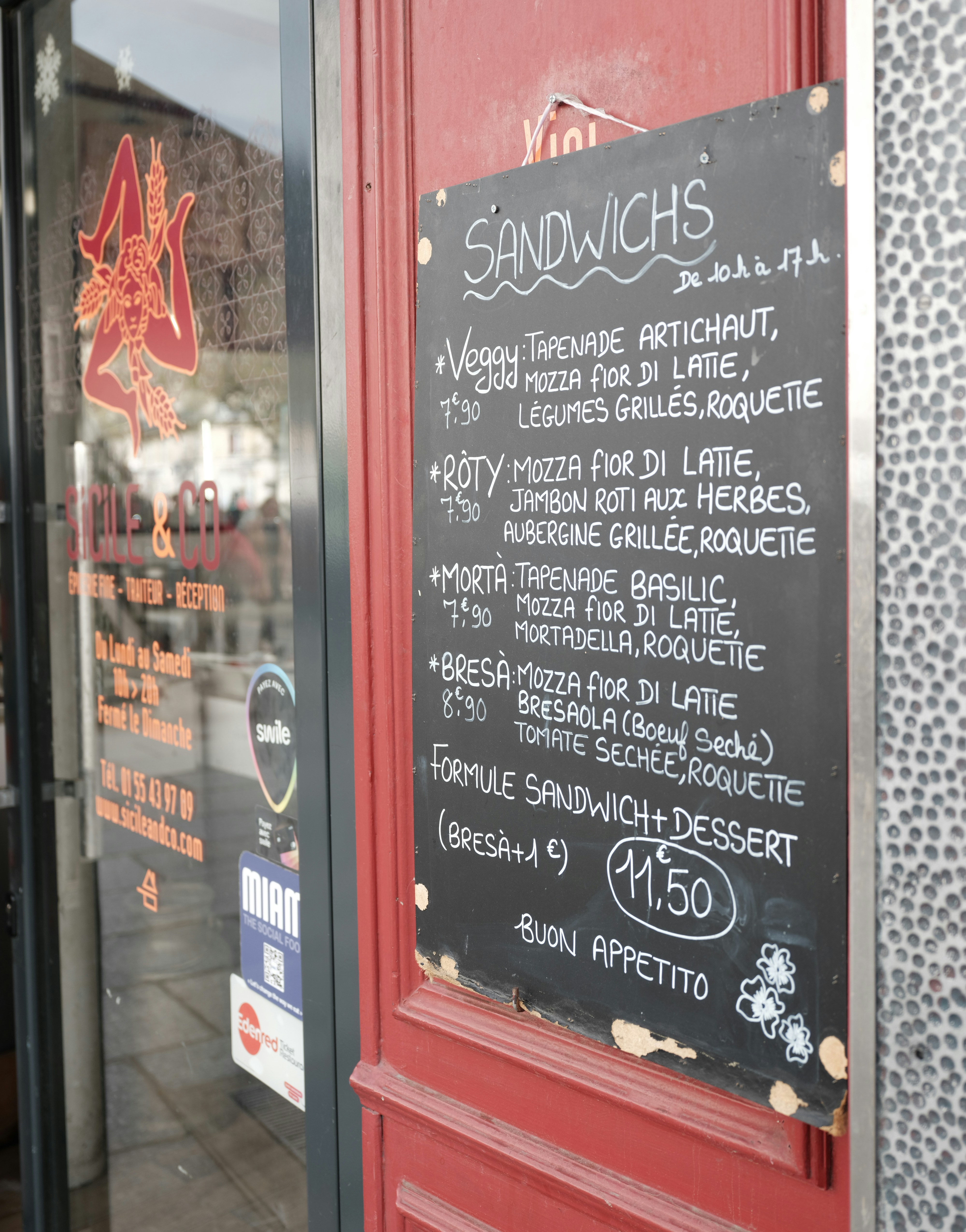 Chalkboard Menu on a Red Door Signaling a Cozy Café