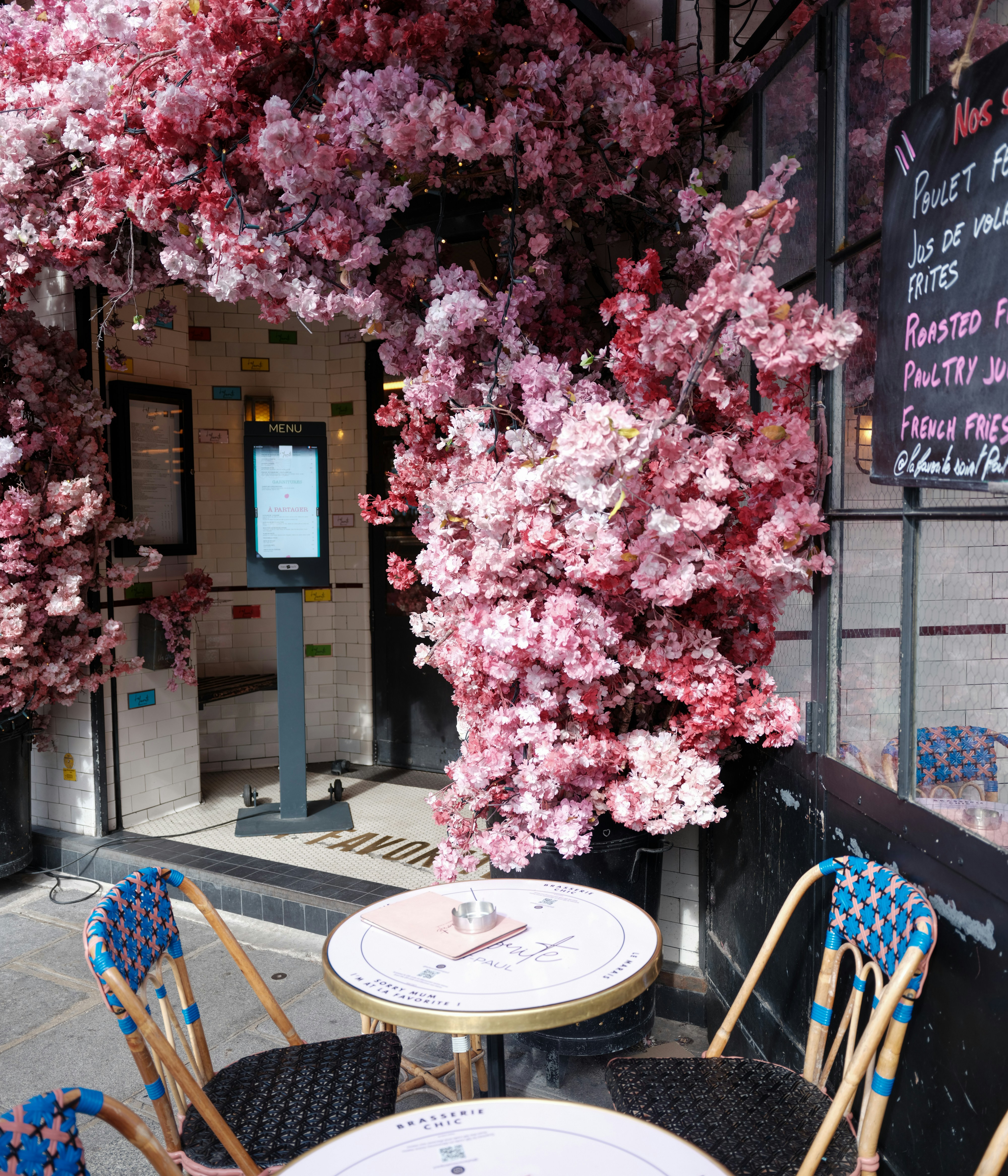 Blooming Bistro Corner Under a Pink Cascade