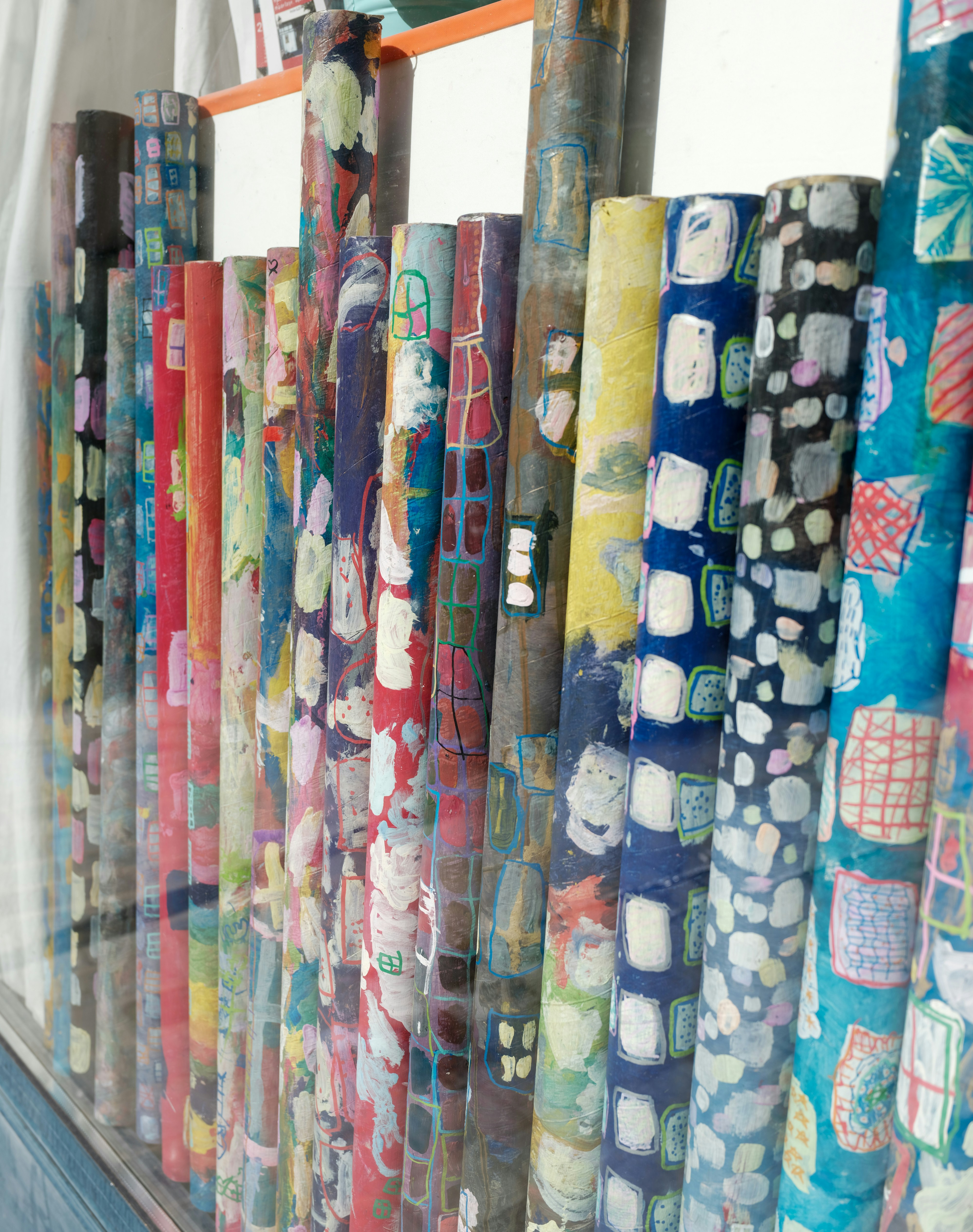 Colorful Cyclades: A Row of Weathered, Painted Cylinders