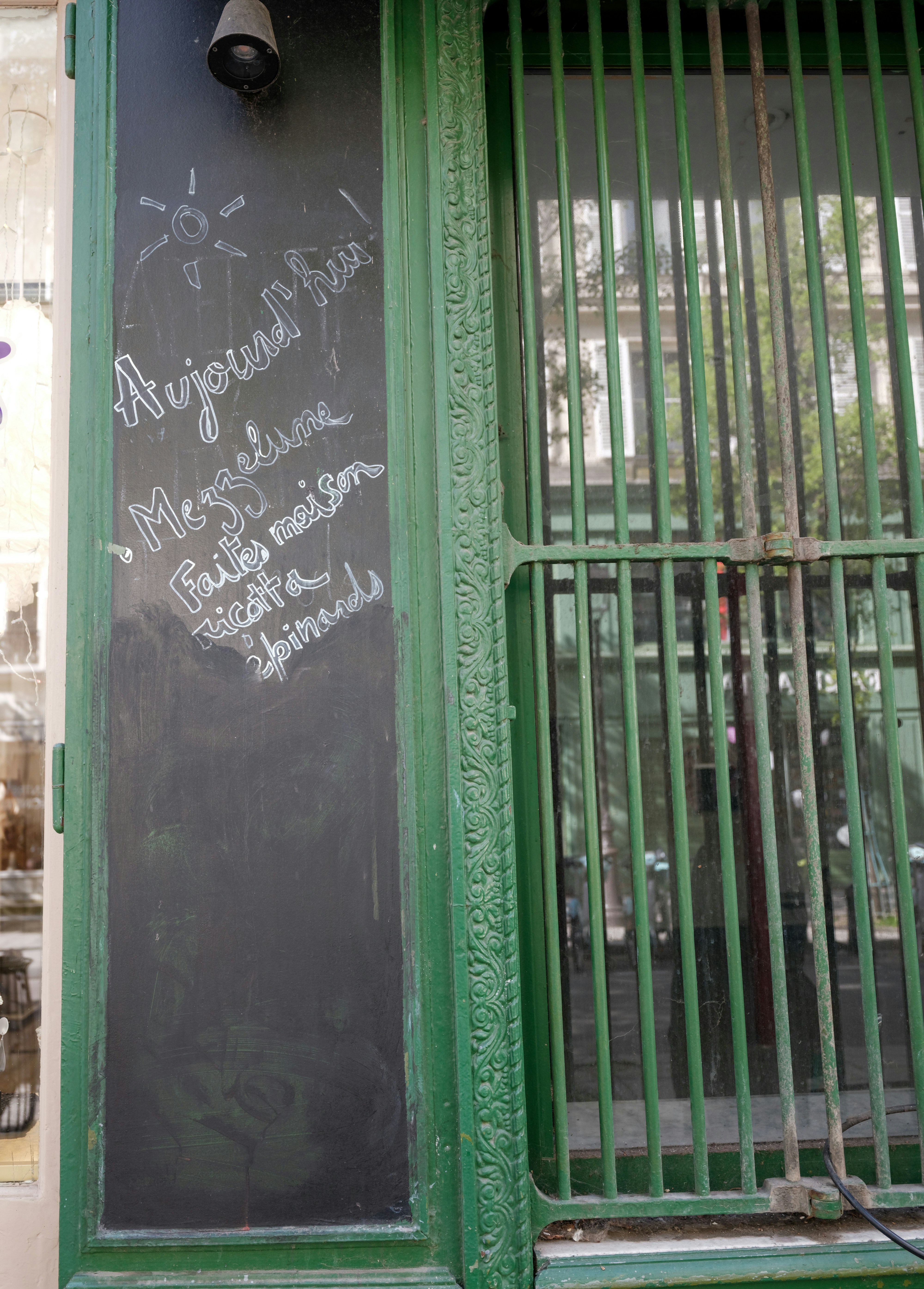 Green Facade and Graffiti Clock: A Quiet Street Corner