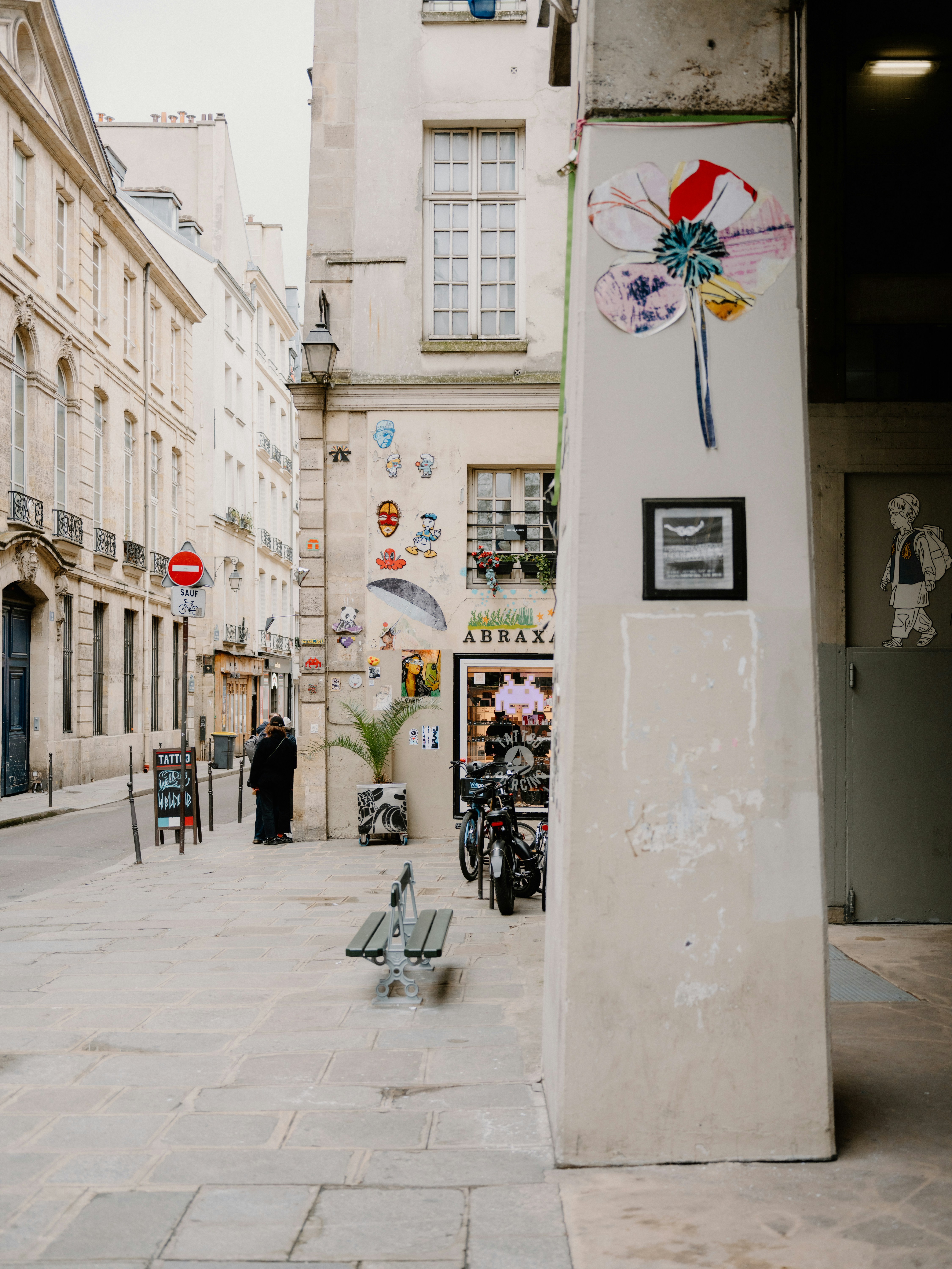 Street art adorns a building column in a european city.