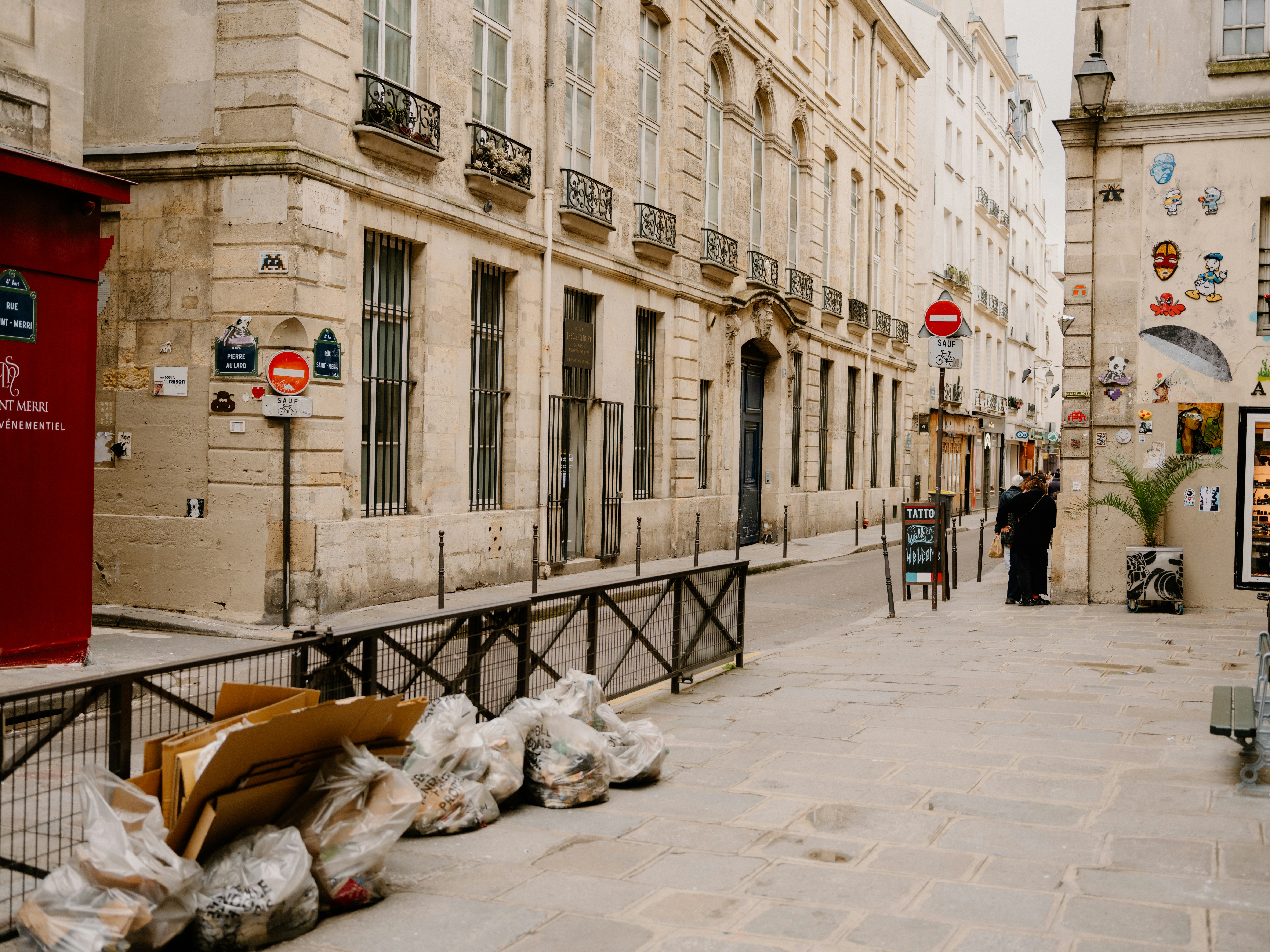 Street scene with buildings and trash bags.