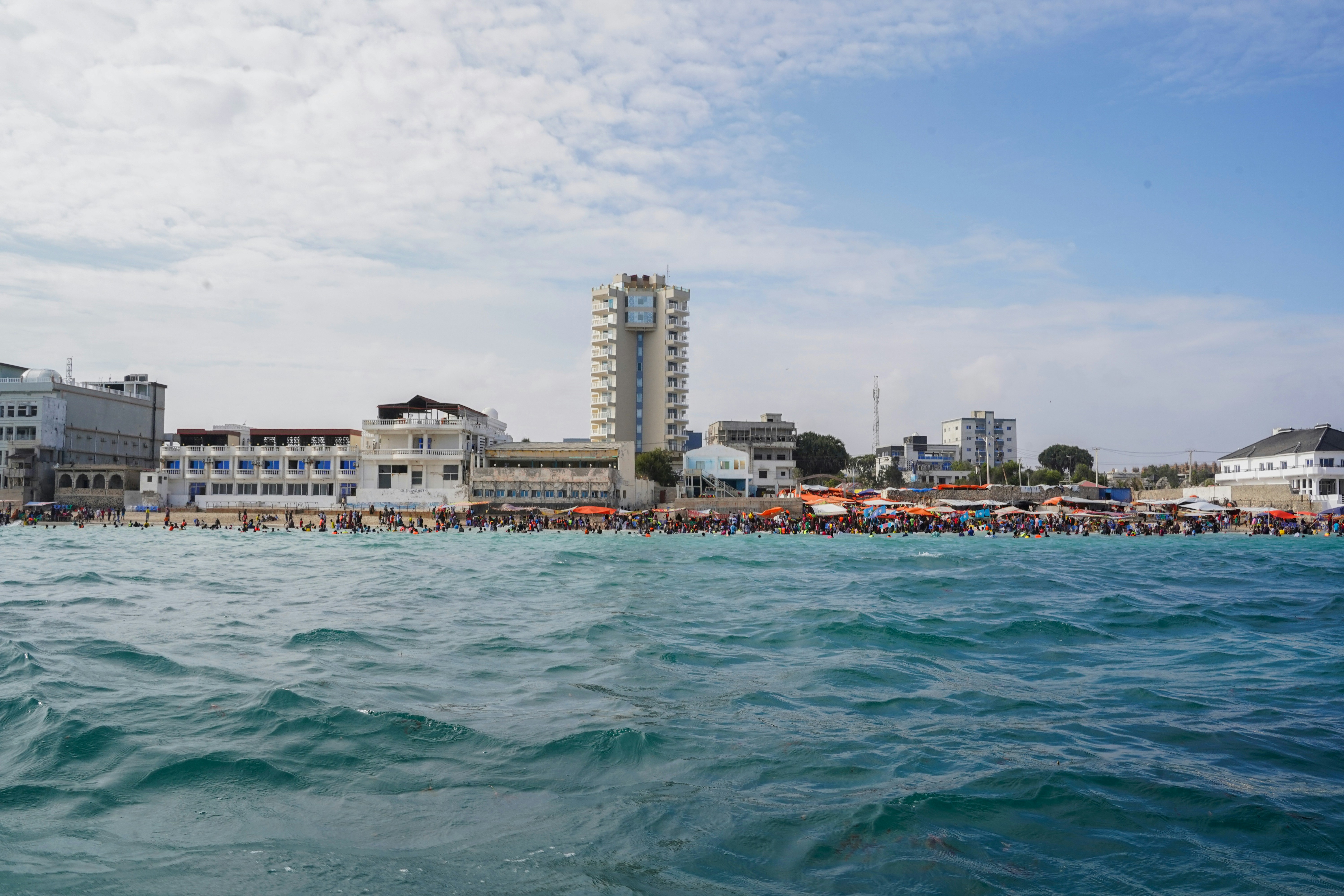 Coastal Pulse: Beachfront Skyline at the Edge of Sea