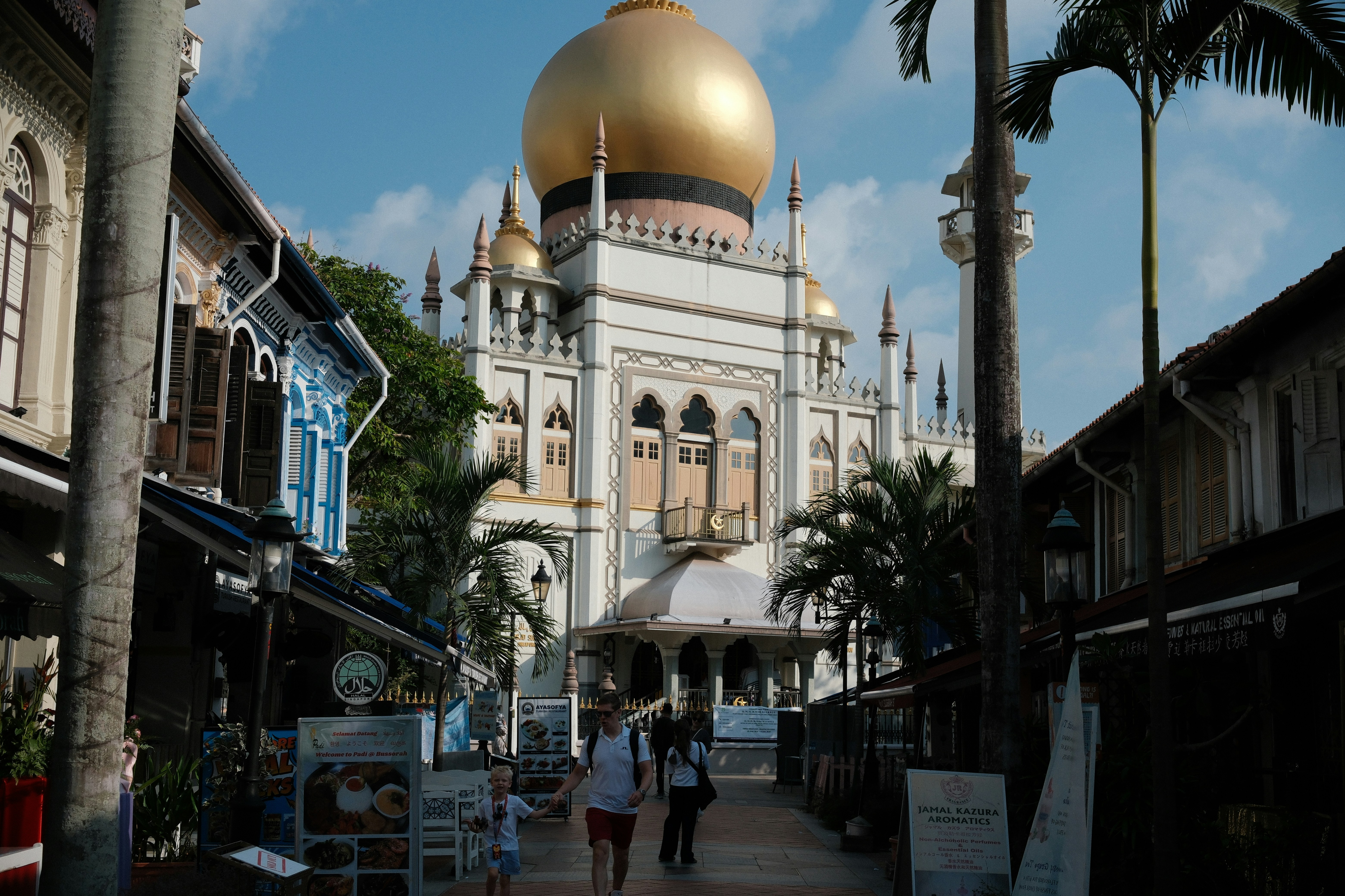 Golden domed mosque viewed down a street