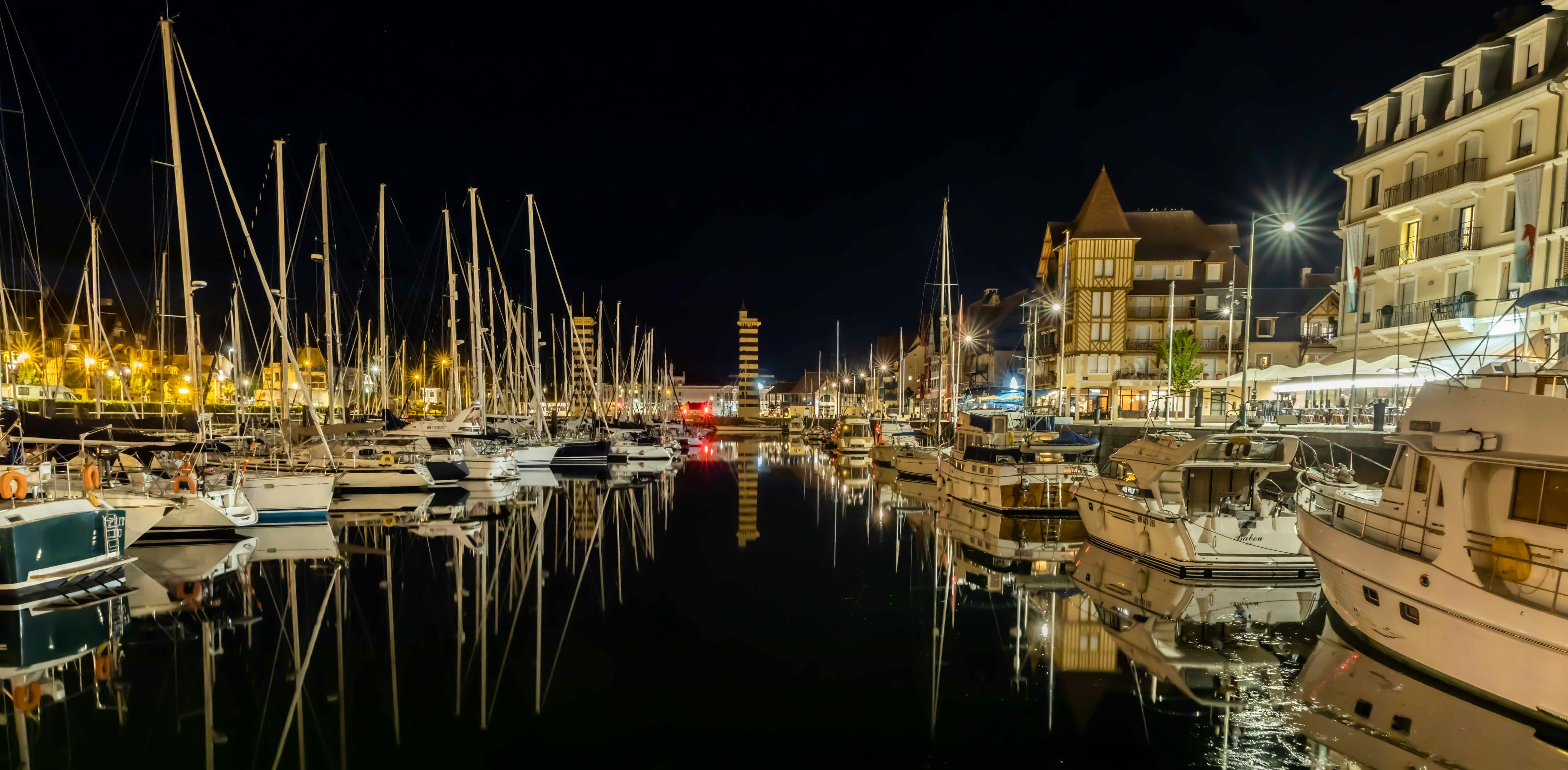 Midnight Channel: Reflections and Masts in a Lantern Waterfront