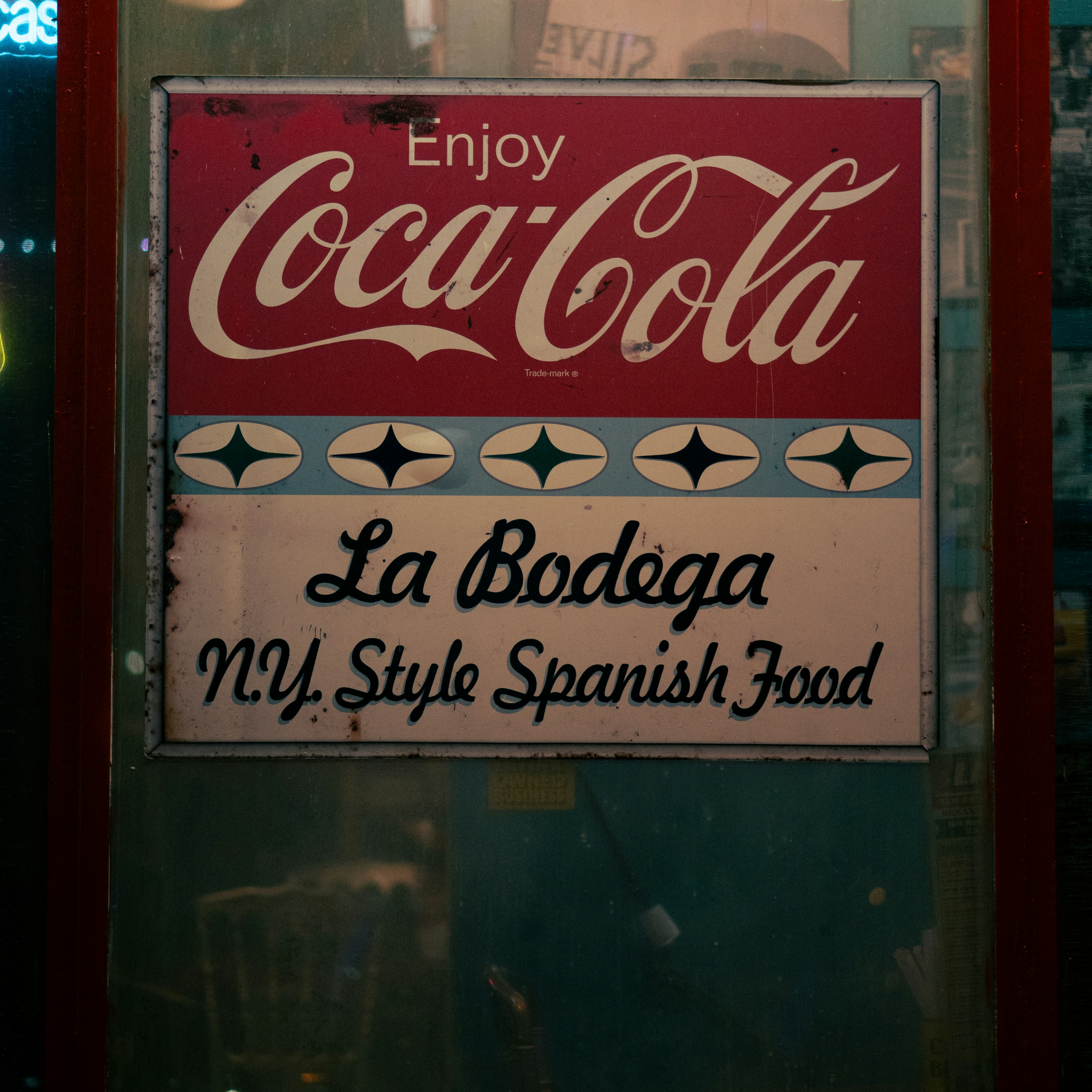 Vintage Coca-Cola Sign in a Weathered Window Frame