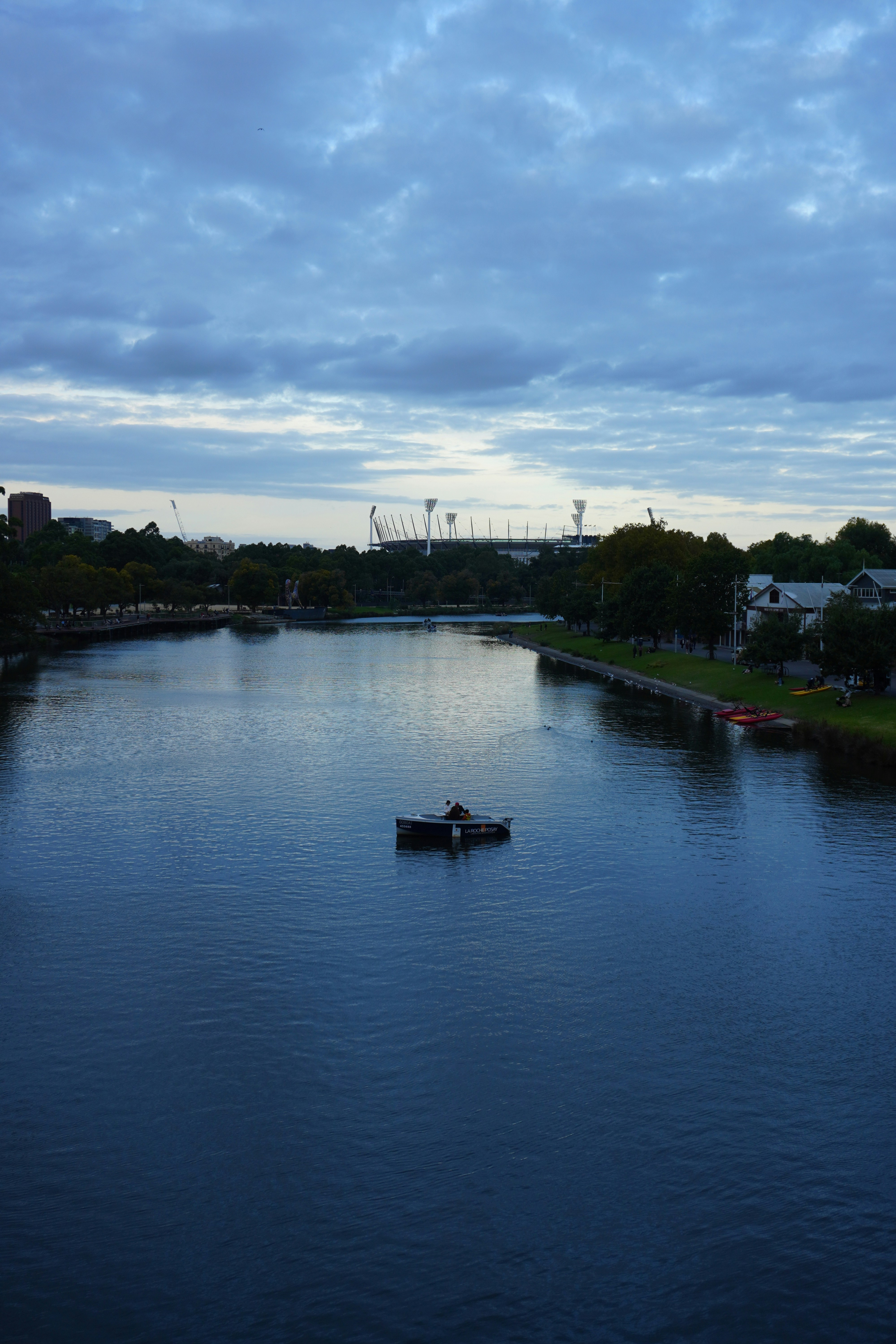 Boat Drift Across the Quiet River at Dusk