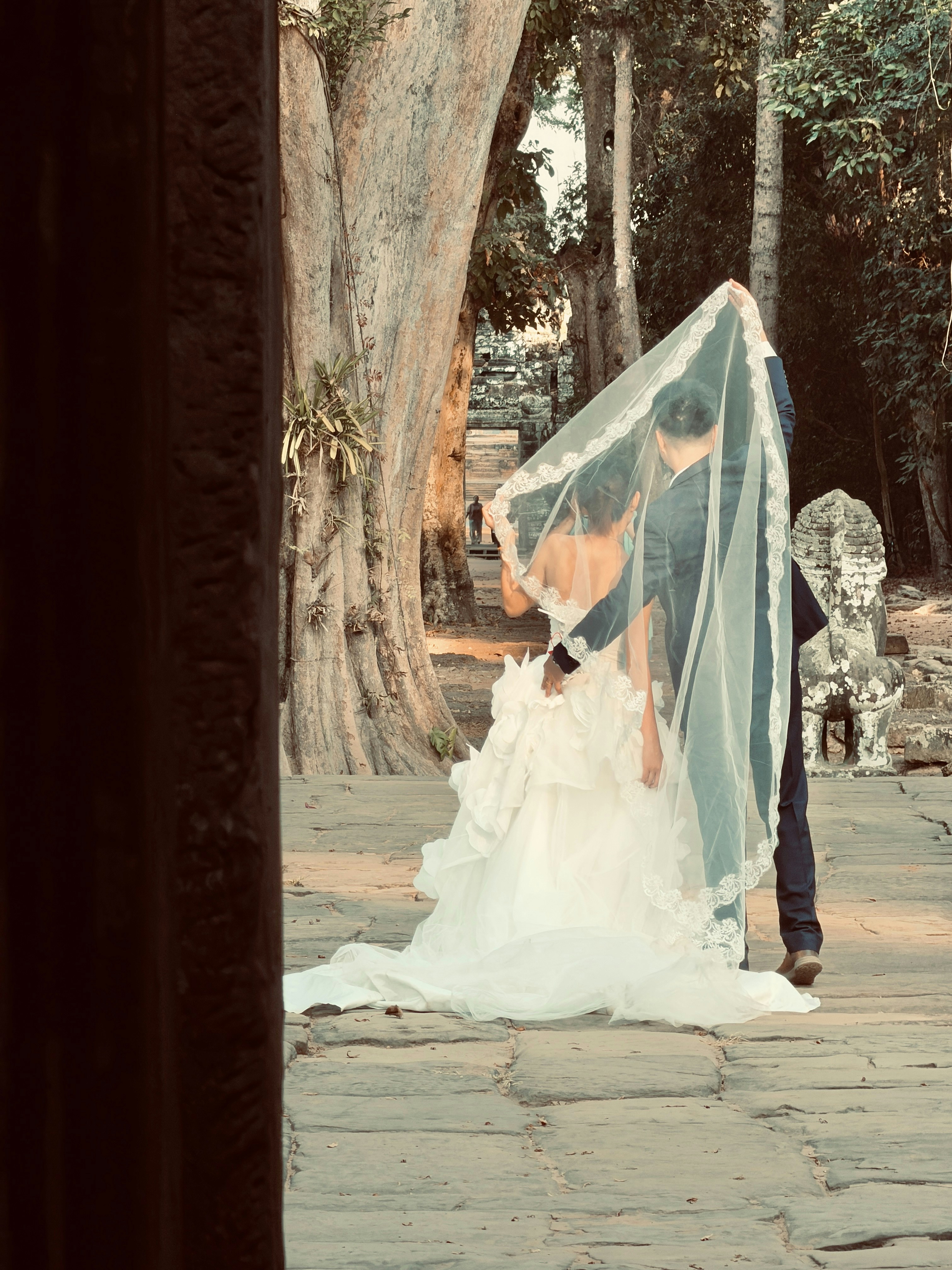 Veiled Union: A Bride and Groom in Soft Cathedral Light