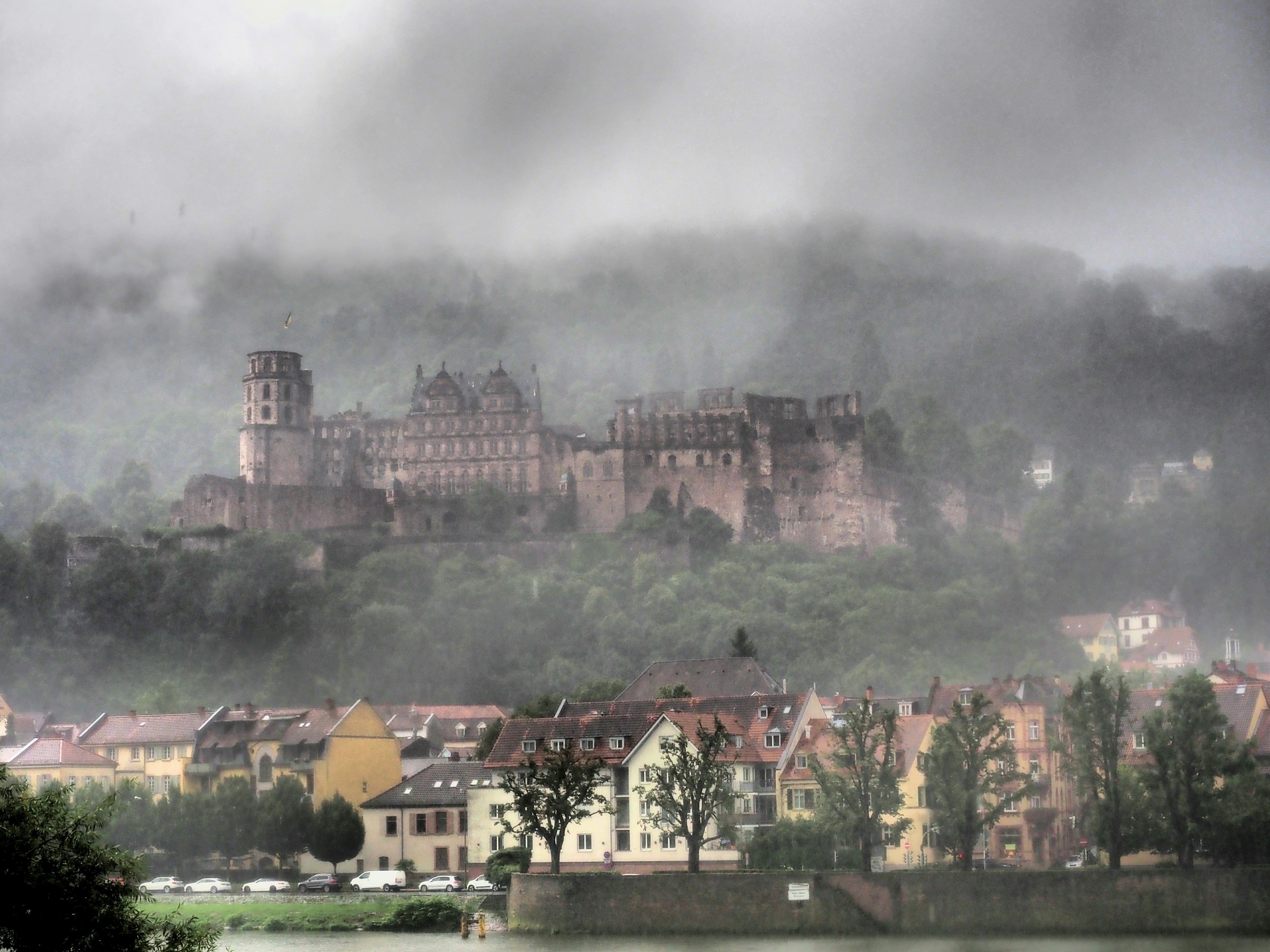 Misty Fortress Over a Quiet Riverfront Town