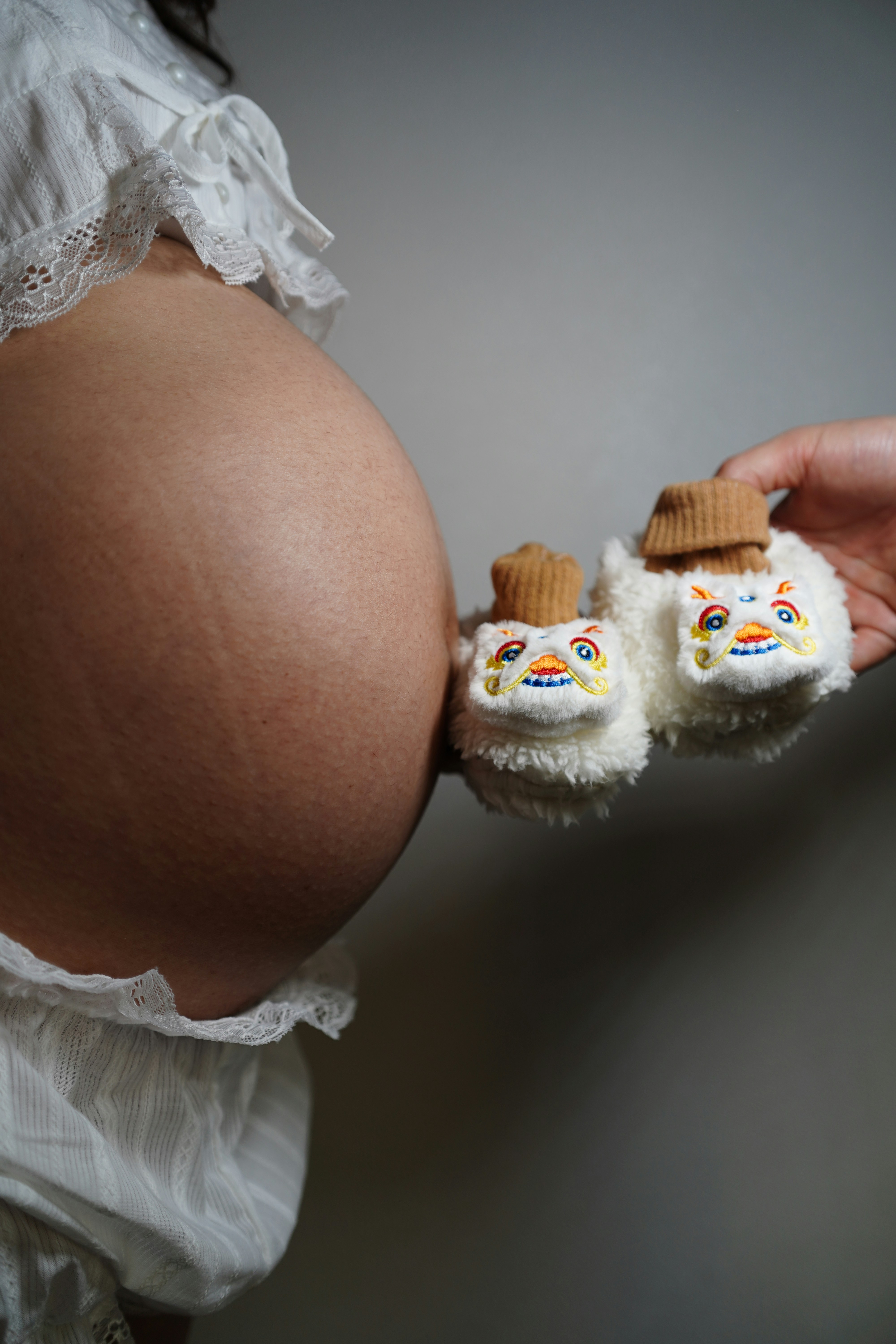 Awaiting the Quirk: Tiny Clown Shoes Hover by a Miraculous Belly