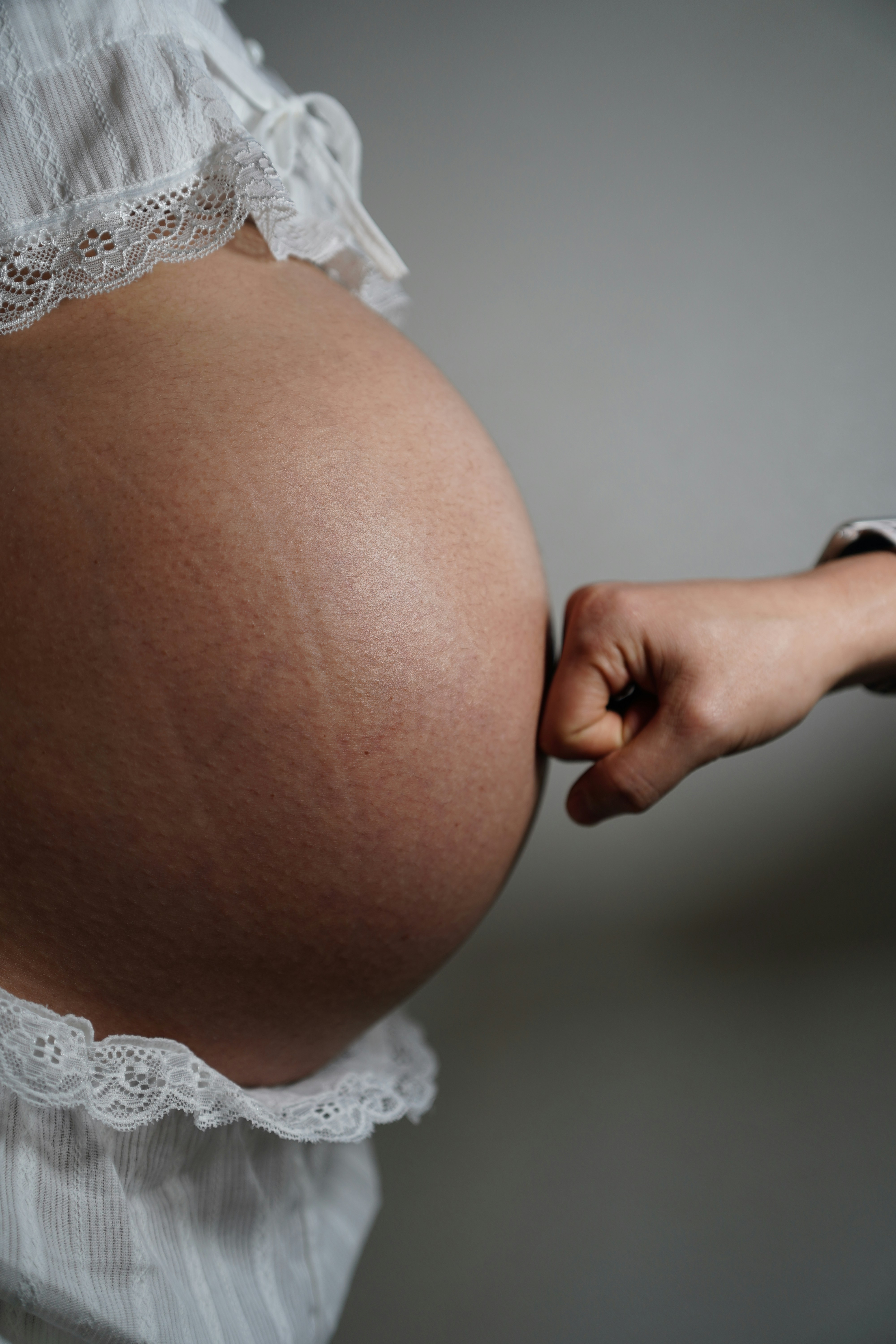 The Ripple of Expectation: A Close Portrait of a Pregnant Moment