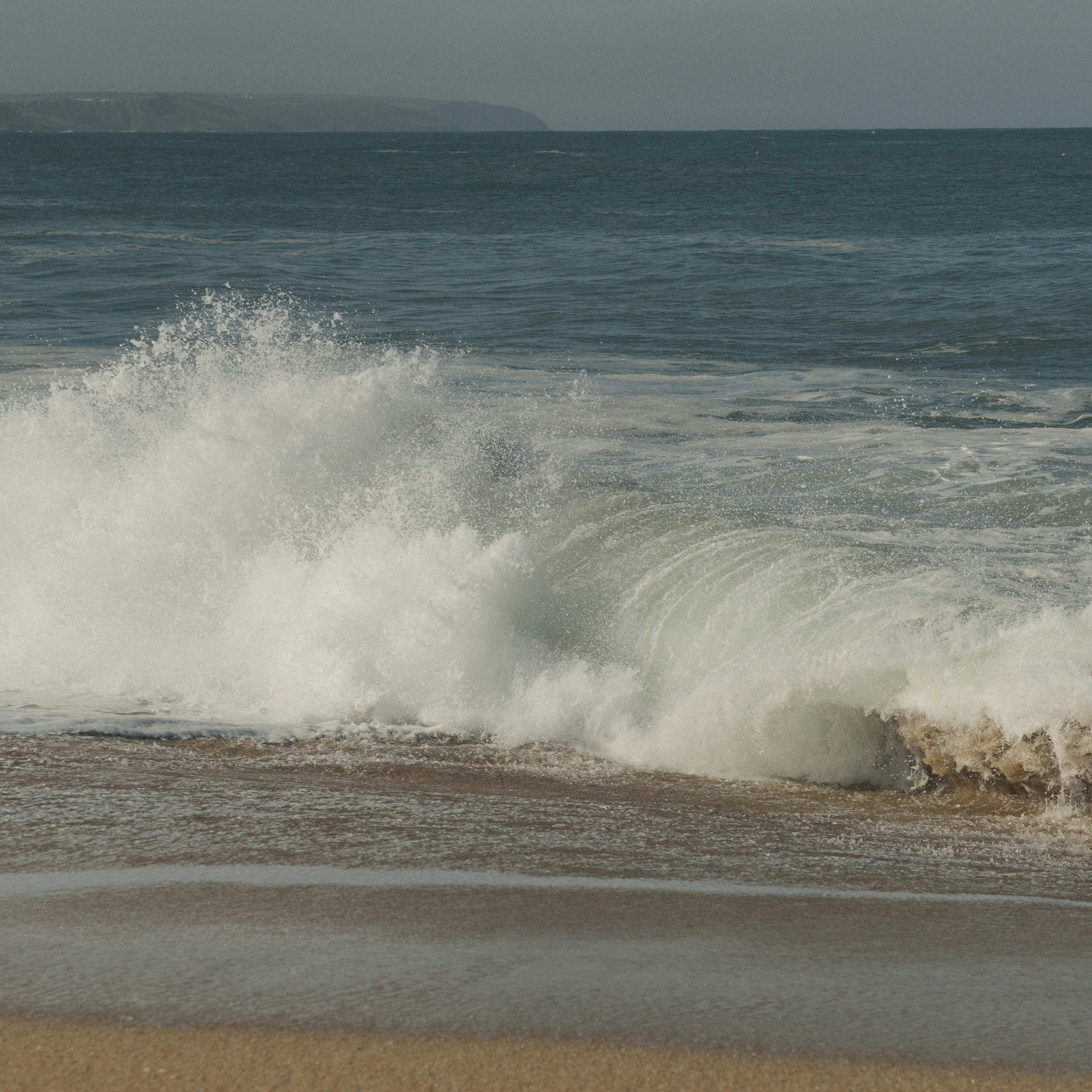 Crepuscular Crest: A Breaking Wave at the Shore
