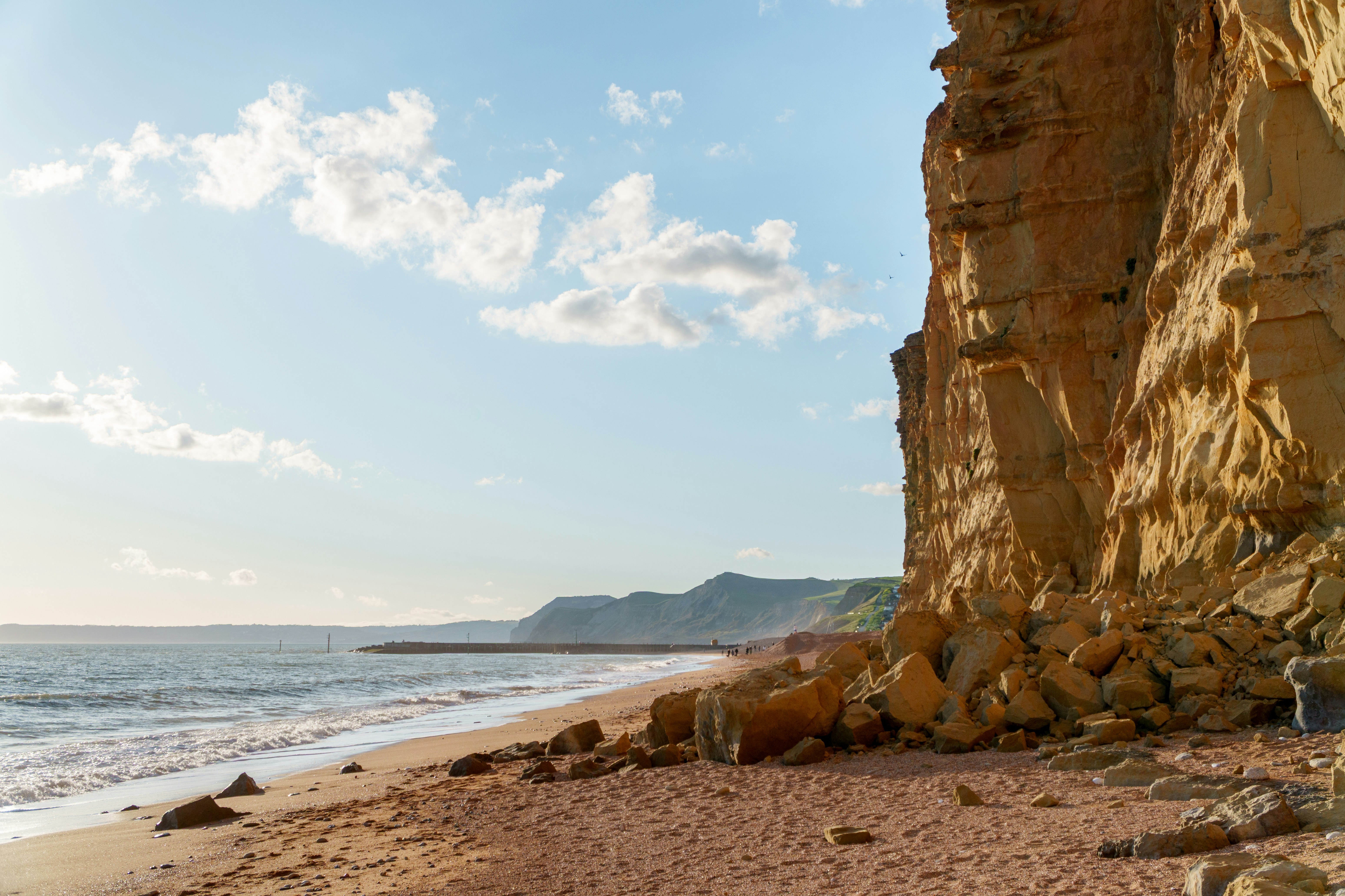 Cliffside Beach at Dusk: Sunlit Stone Faces the Quiet Sea
