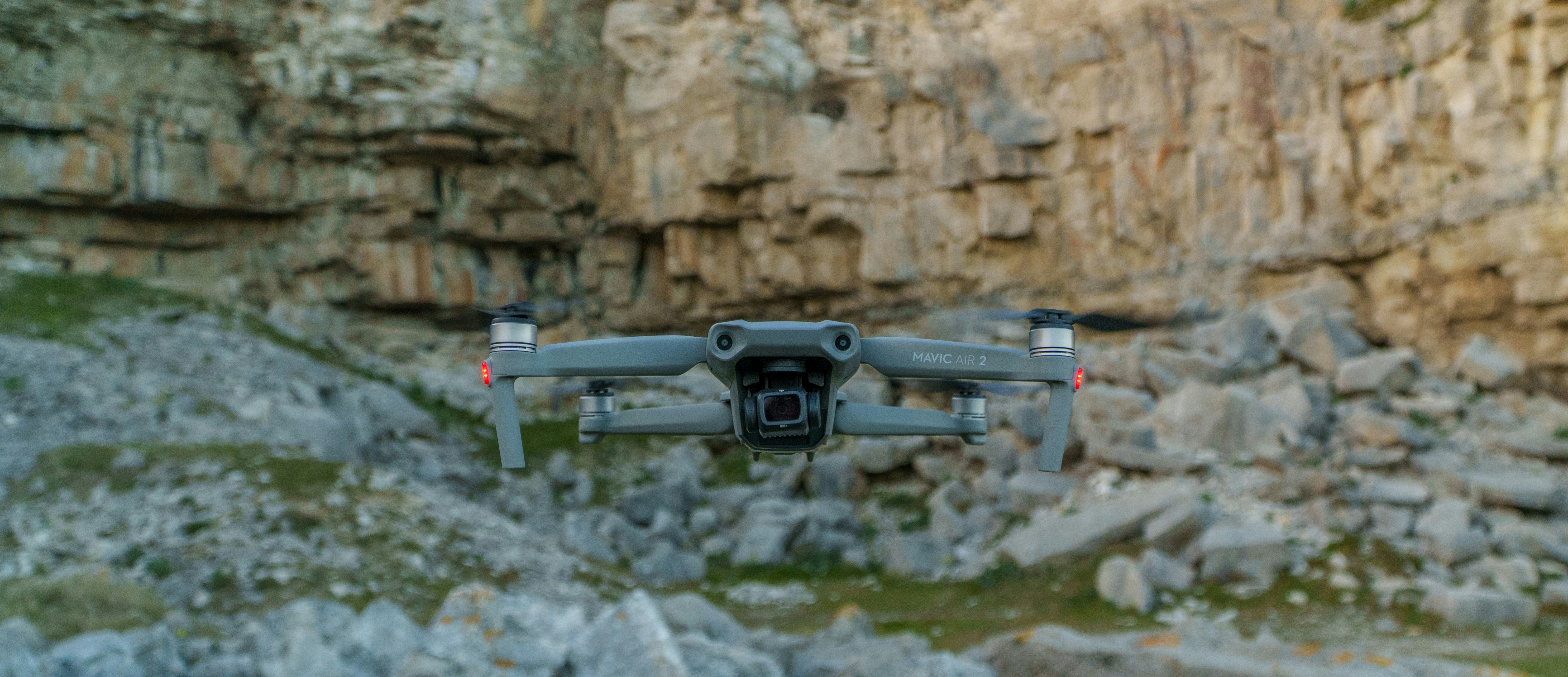 Riverbed Recon: A Drone Glides Below a Cliff Line