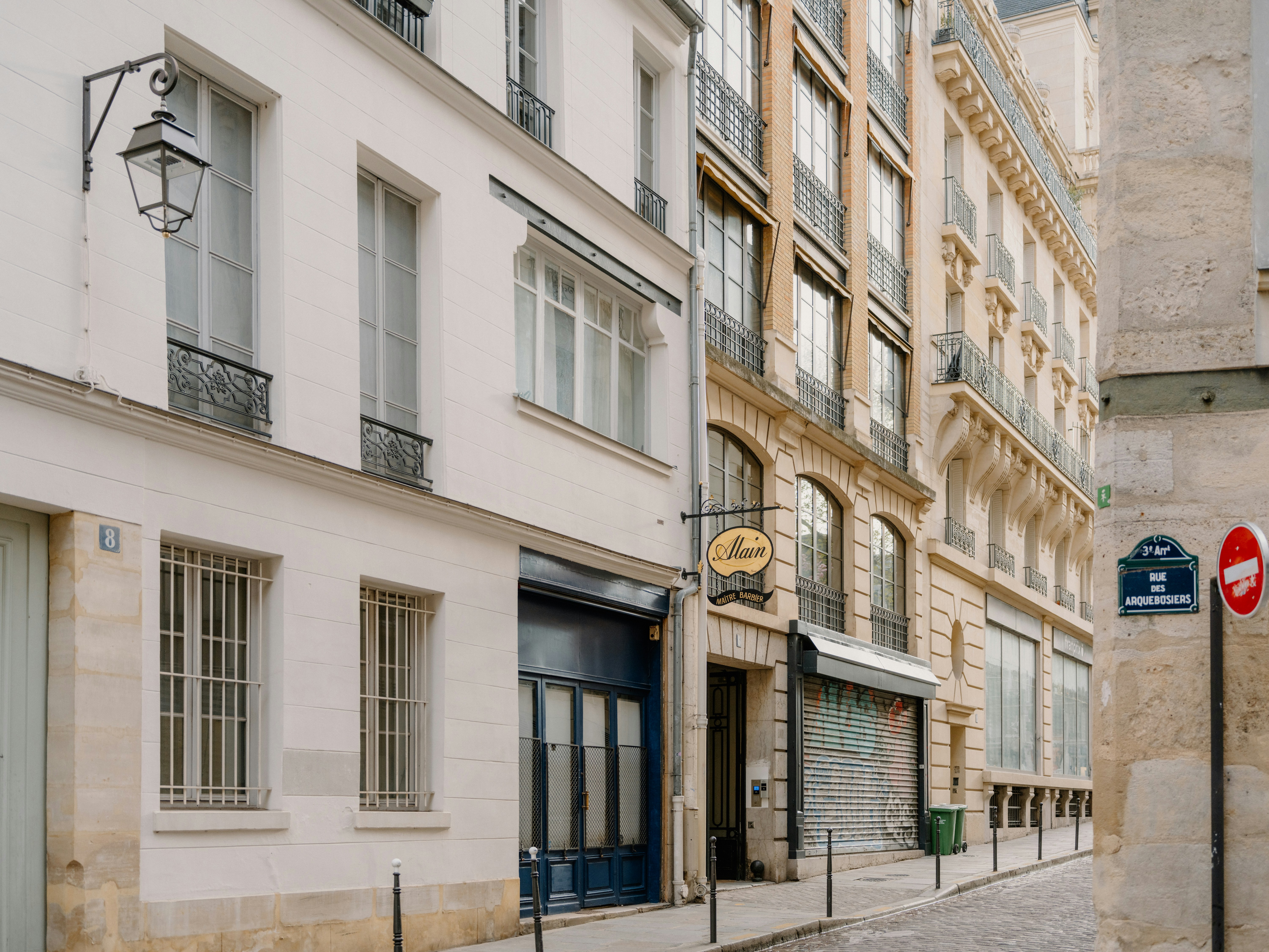 Sunlit Parisian Street: A Quiet Corridor Between Historic Facades