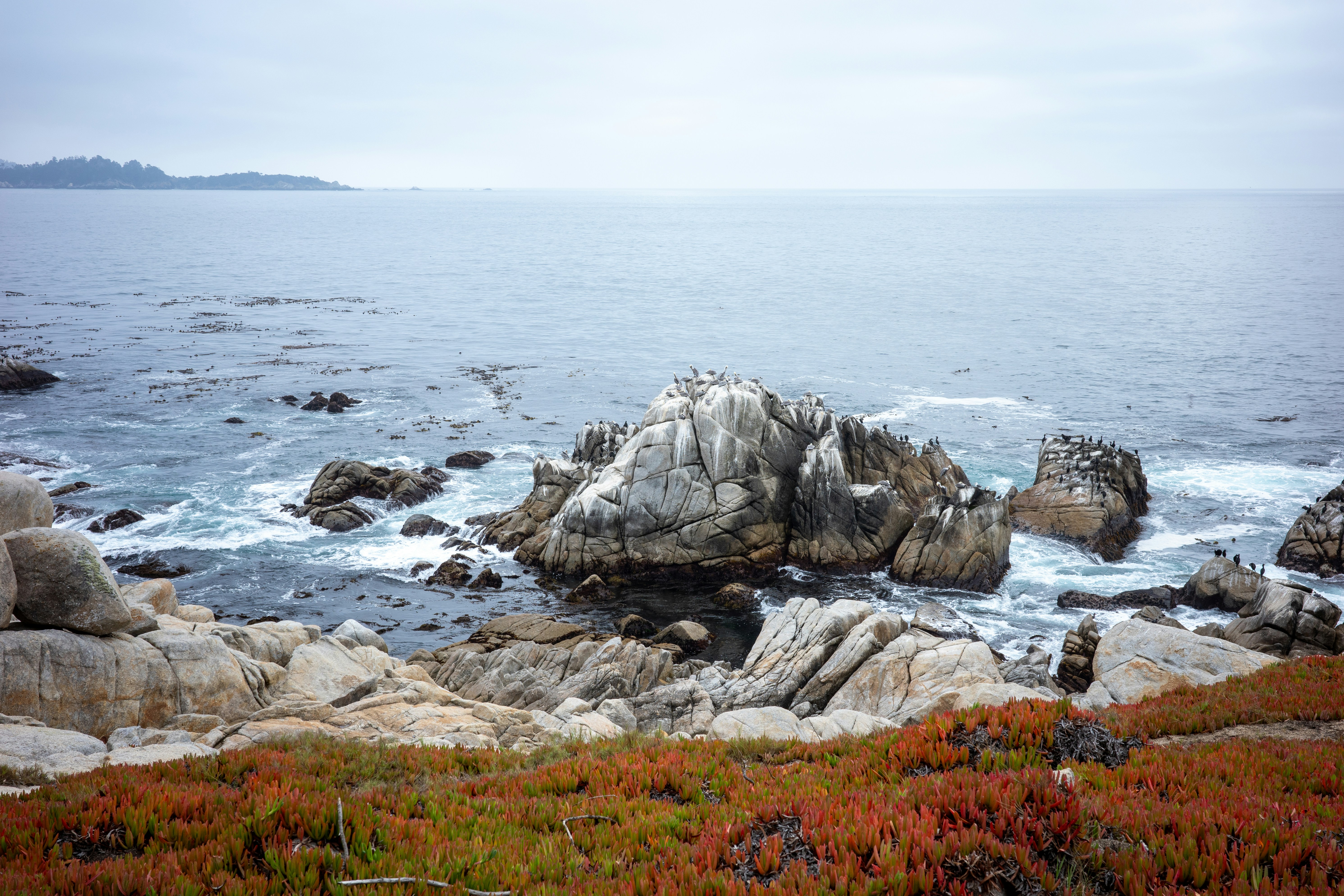 Rugged Rocks Meet the Quiet Sea at Dusk