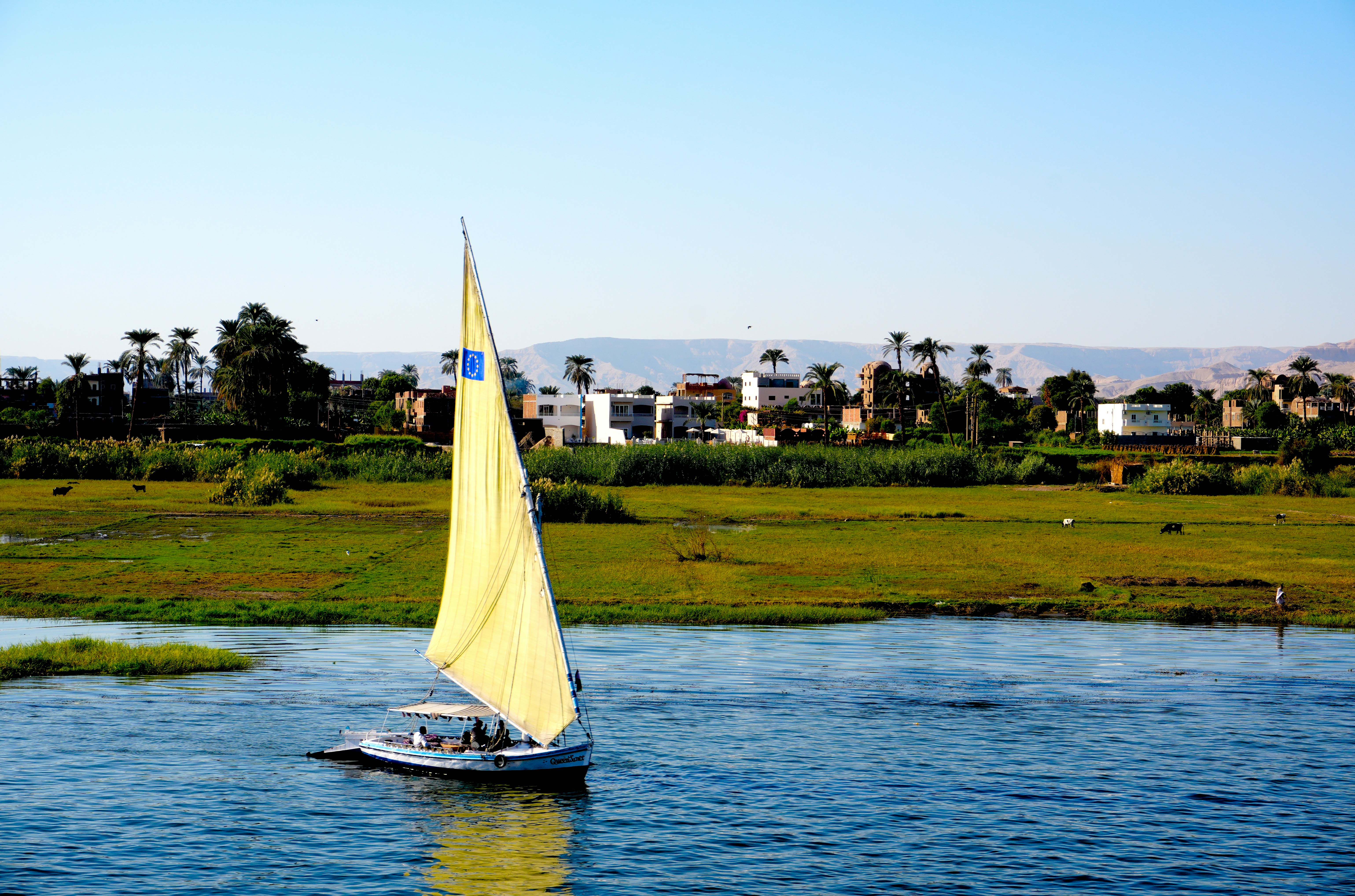 Sailboat Slice: A Lone Sail Pierces Calm River