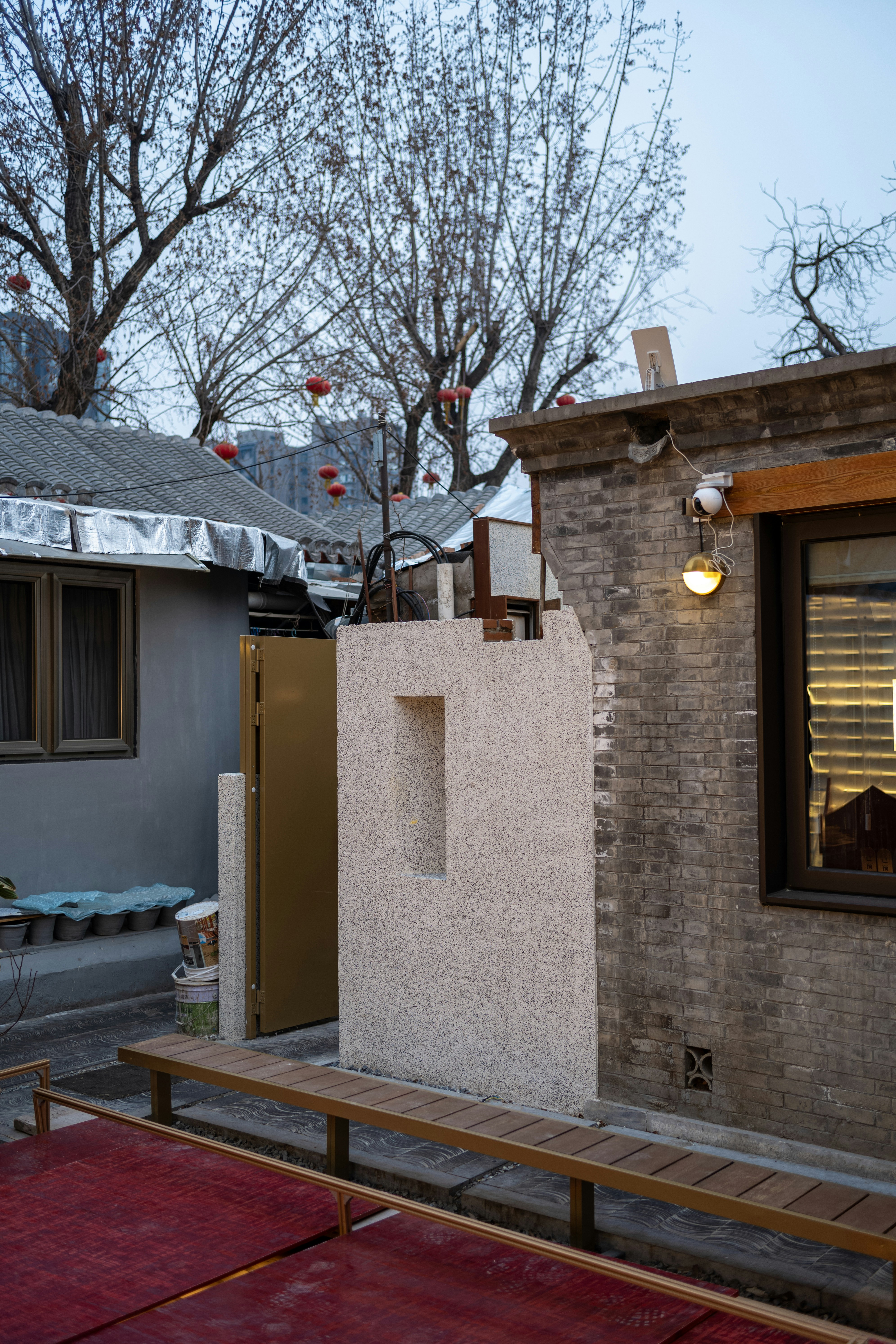 Quiet Courtyard with Red Lanterns and Textured Brick