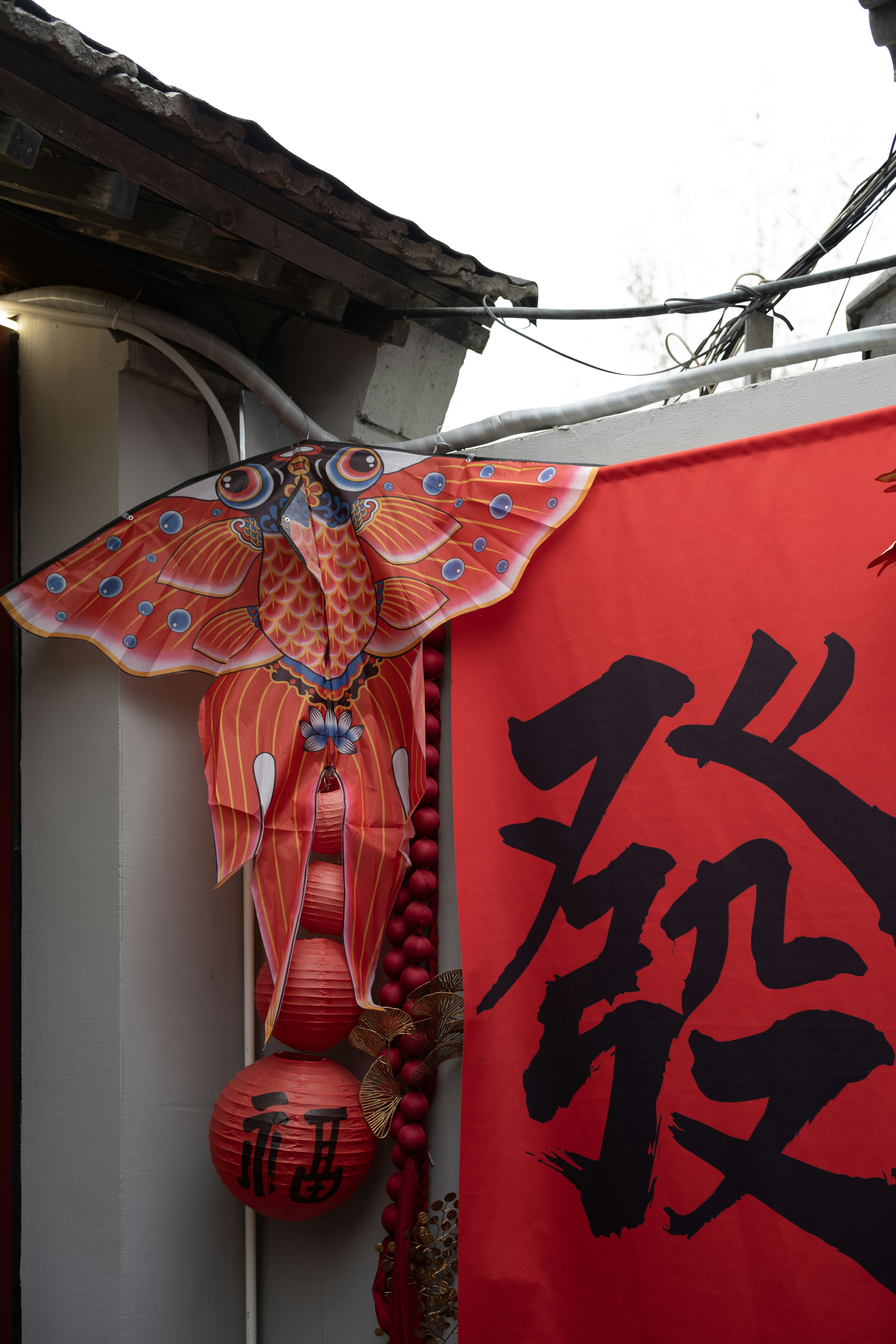 Red Kite Lanterns and Bold Calligraphy adorn a festive doorway