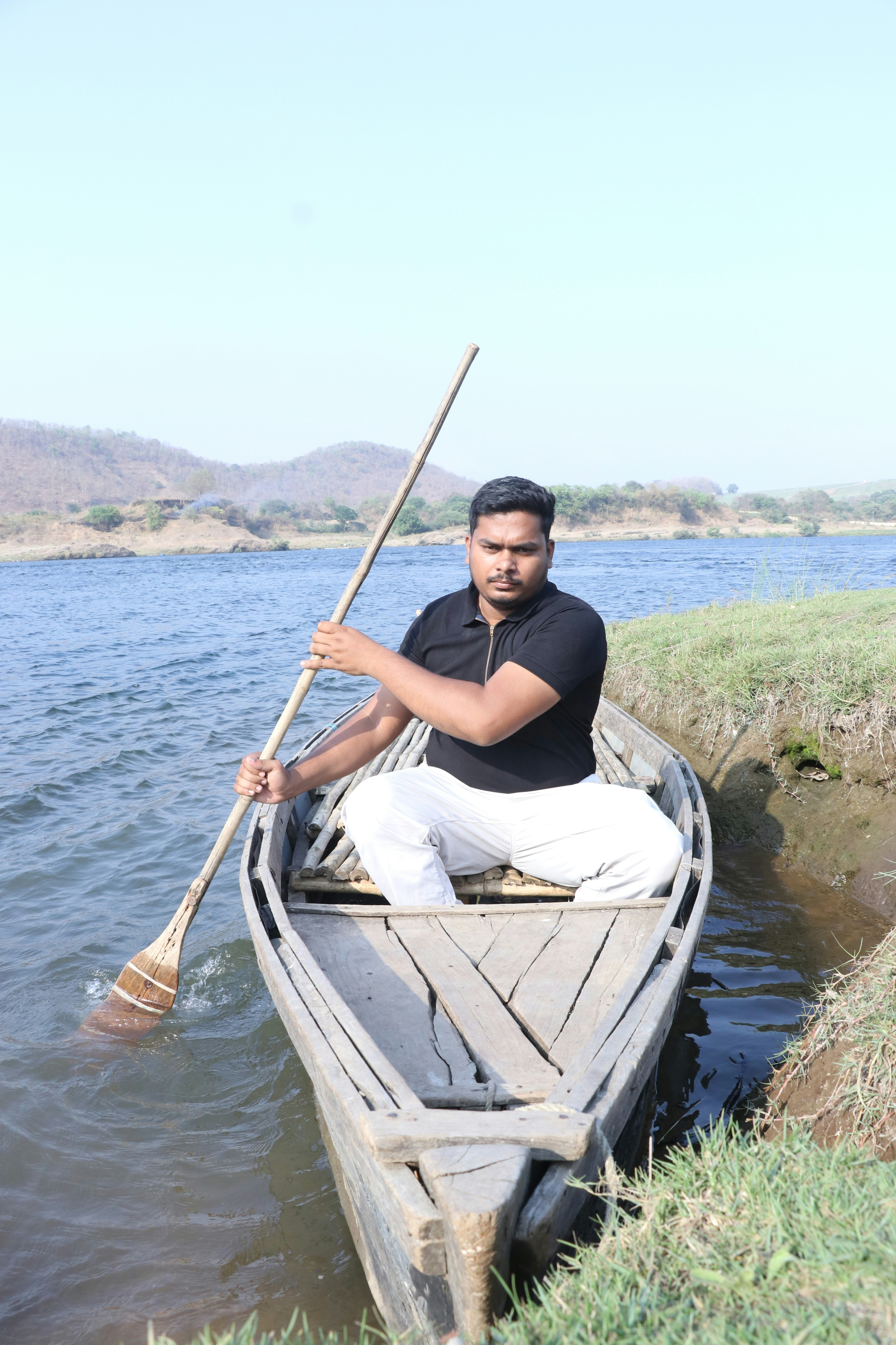 Oarsman in a Quiet Waterway: A Moment of Balance