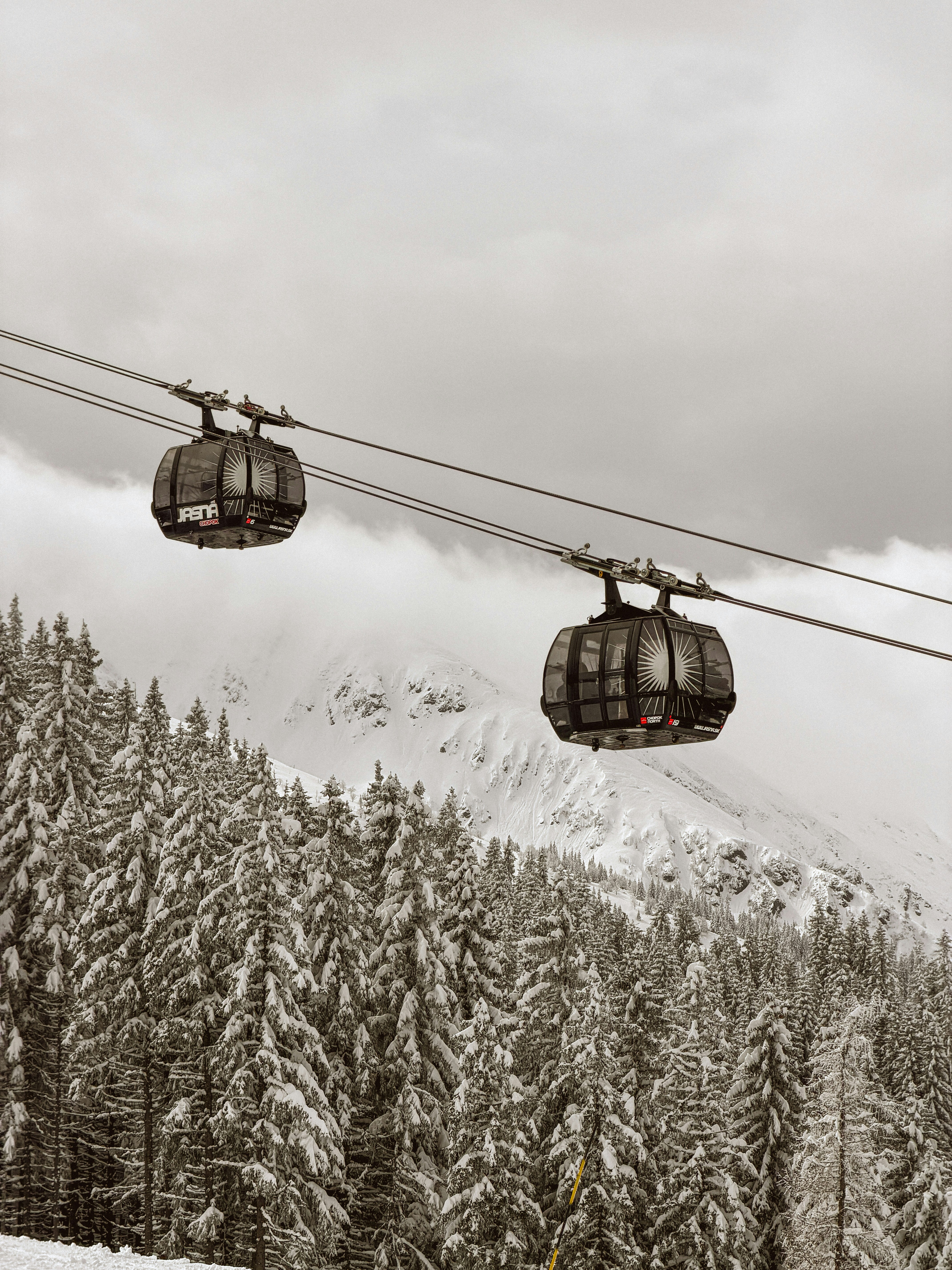 Snowbound Ascent: Twin Gondolas Across a Quiet Mountain Veil