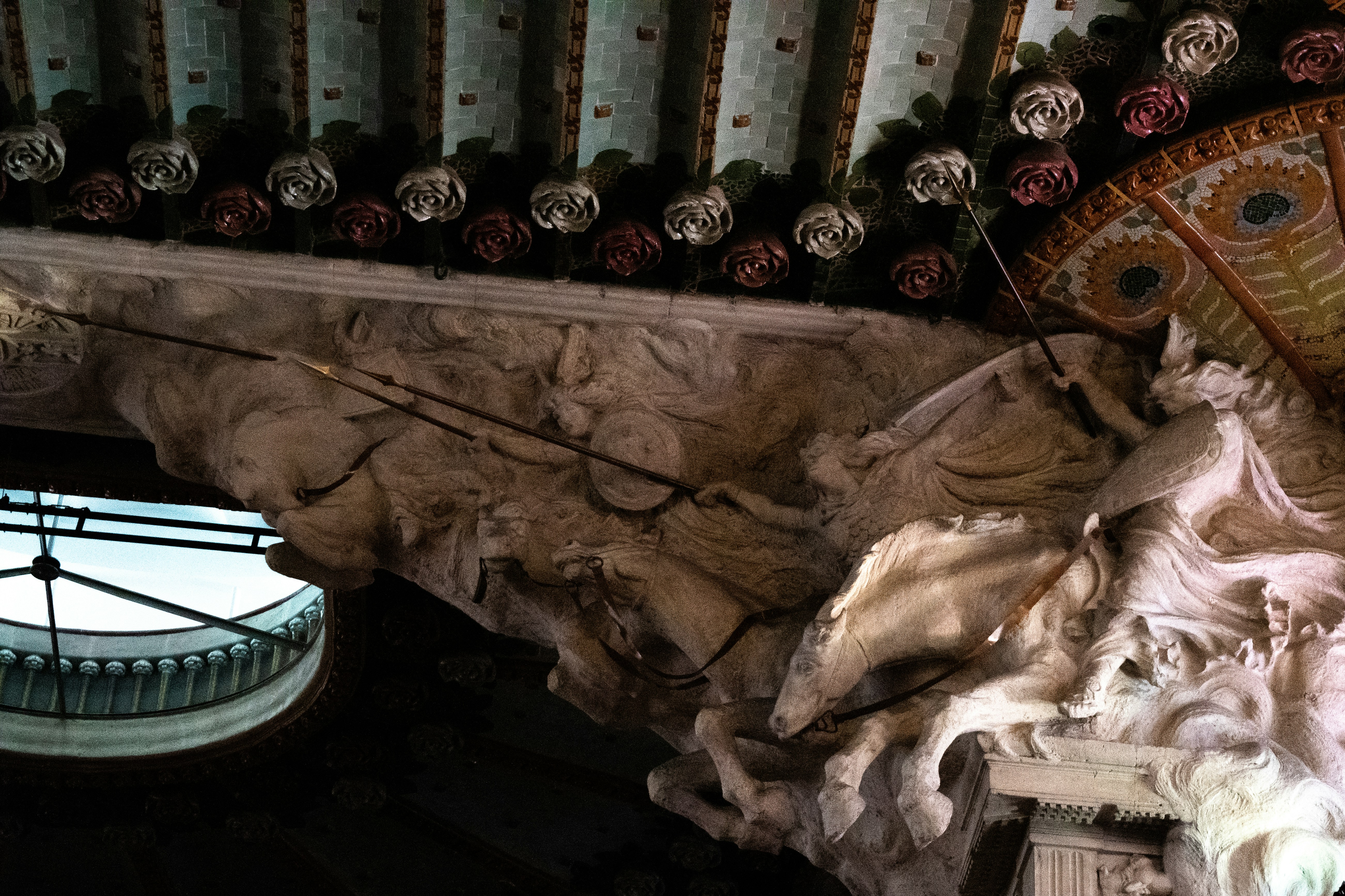 Stone Sculptures and Ornate Ceiling Beneath a Circular Skylight