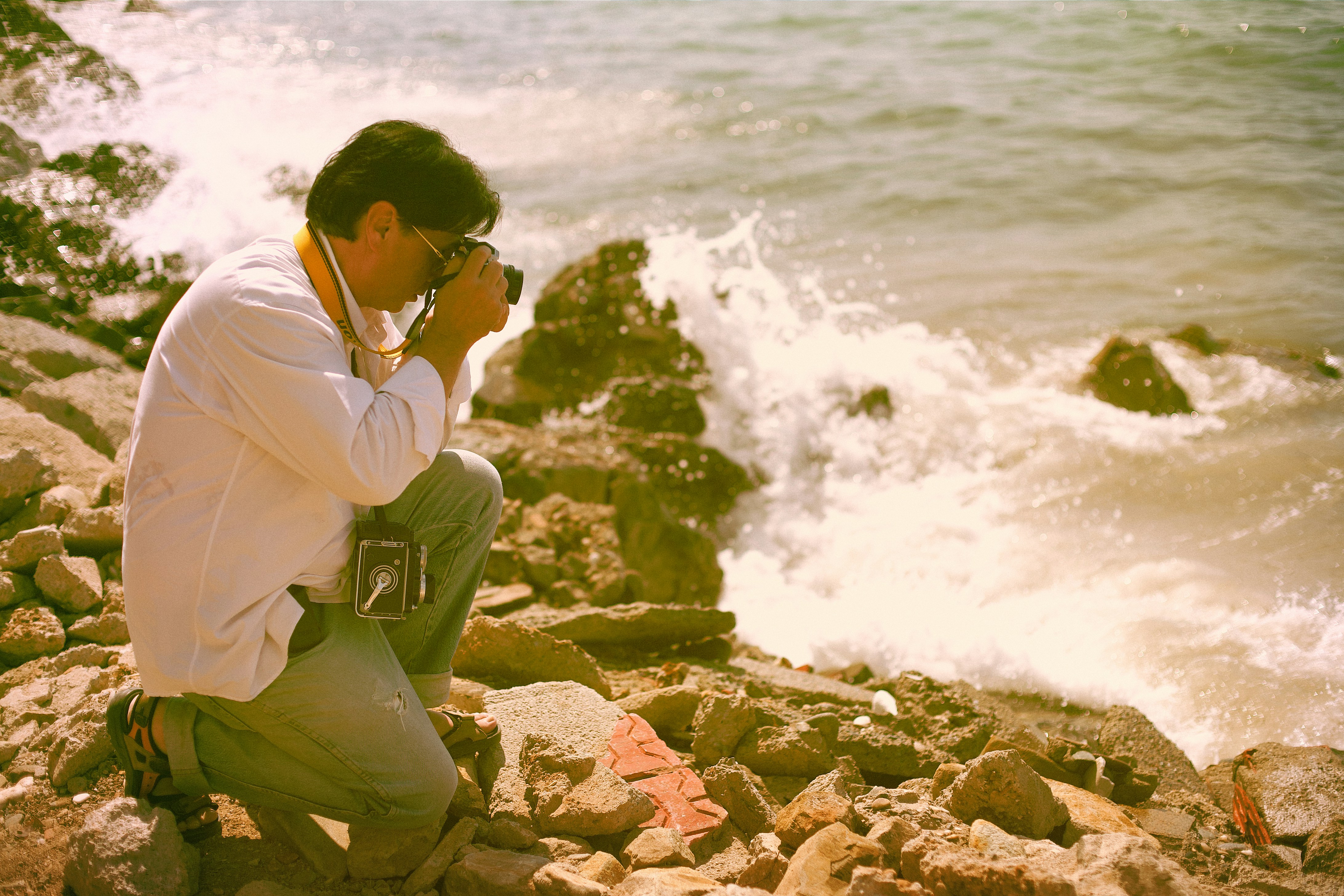 Coastal Portrait in the Rocks: A Photographer at the Edge of Surf