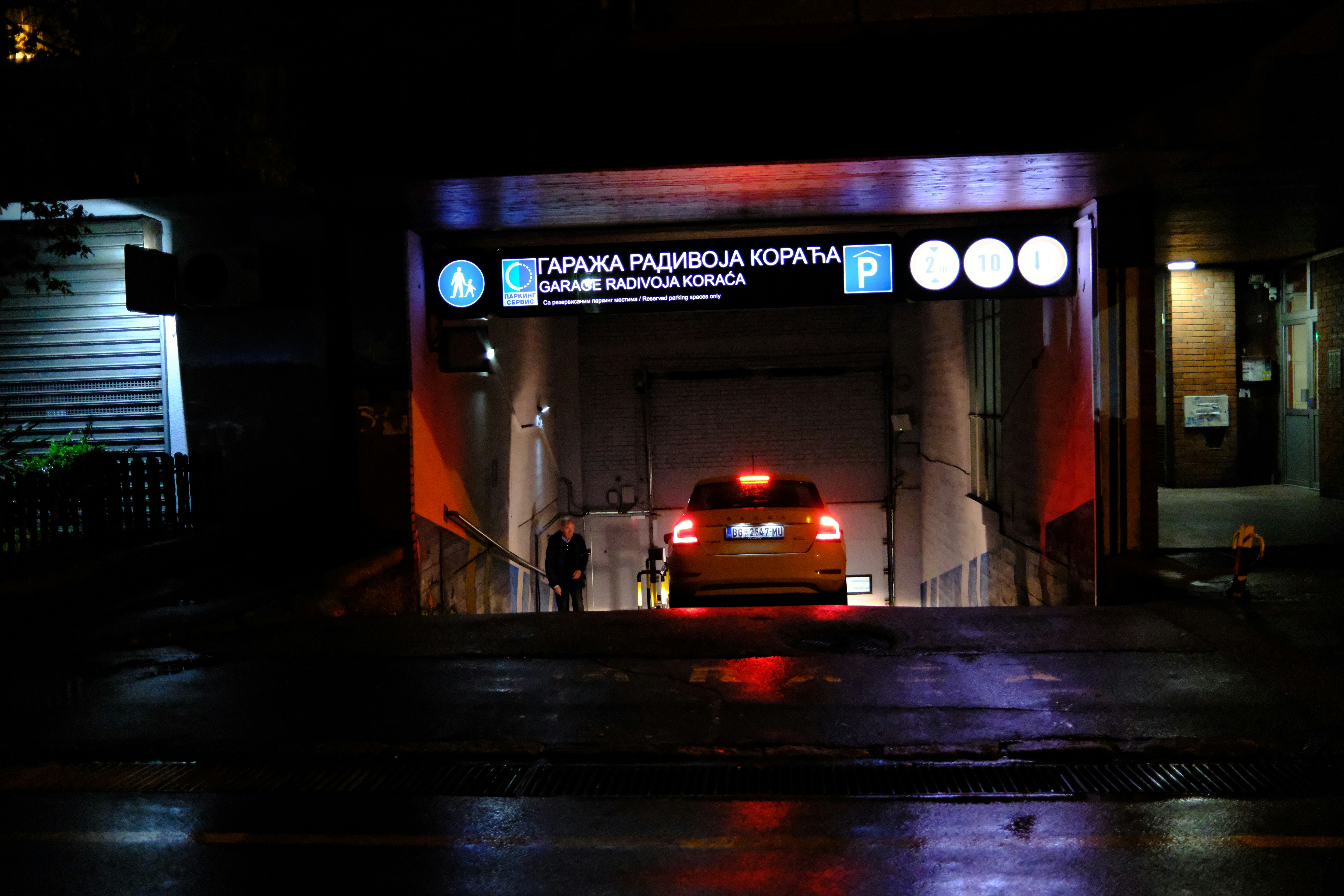 Night Descent: Car Emerging from a Dim Parking Garage