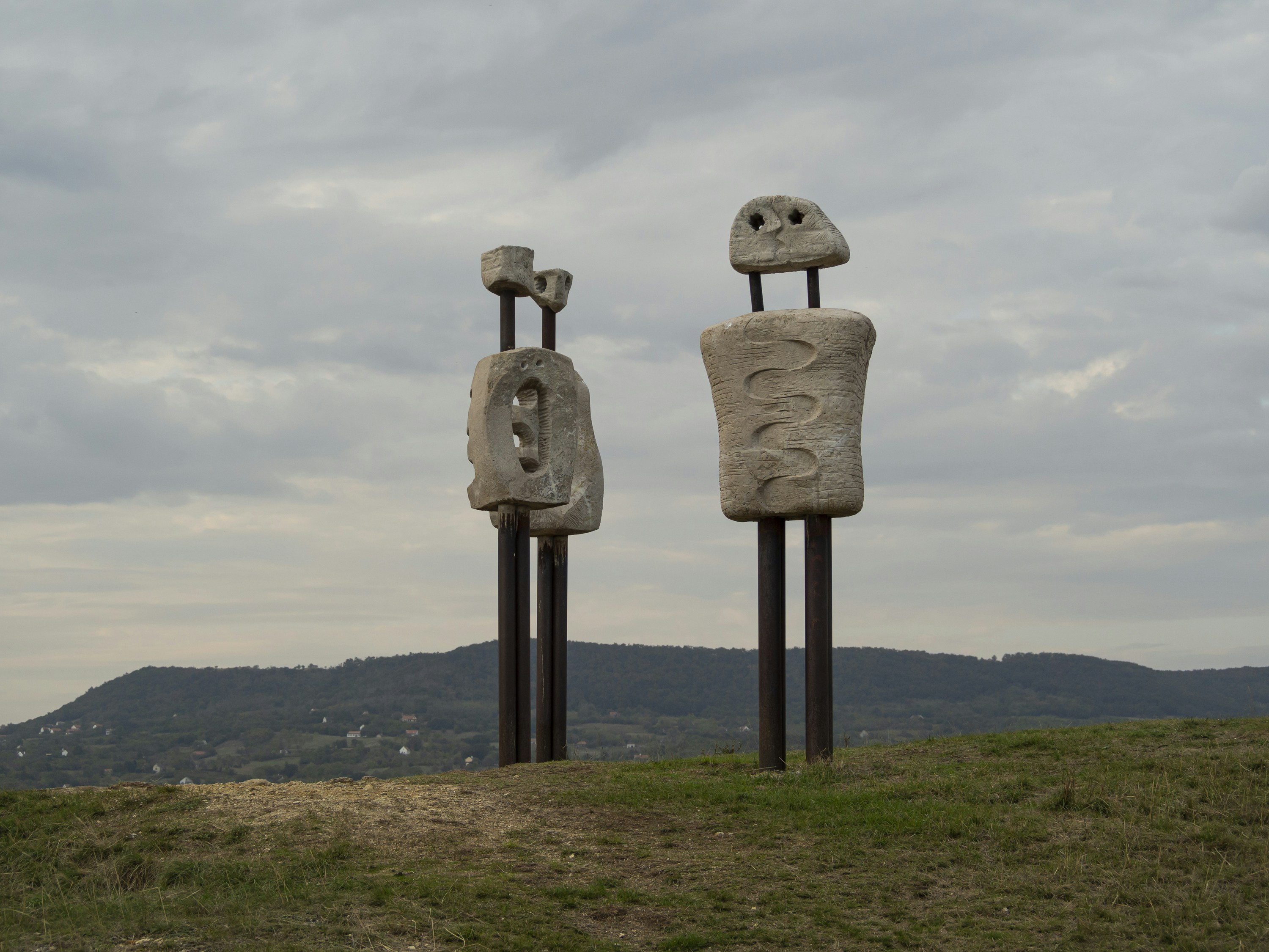 Stone Figures on a Hilltop: Concrete Sculptures Against a Quiet Horizon