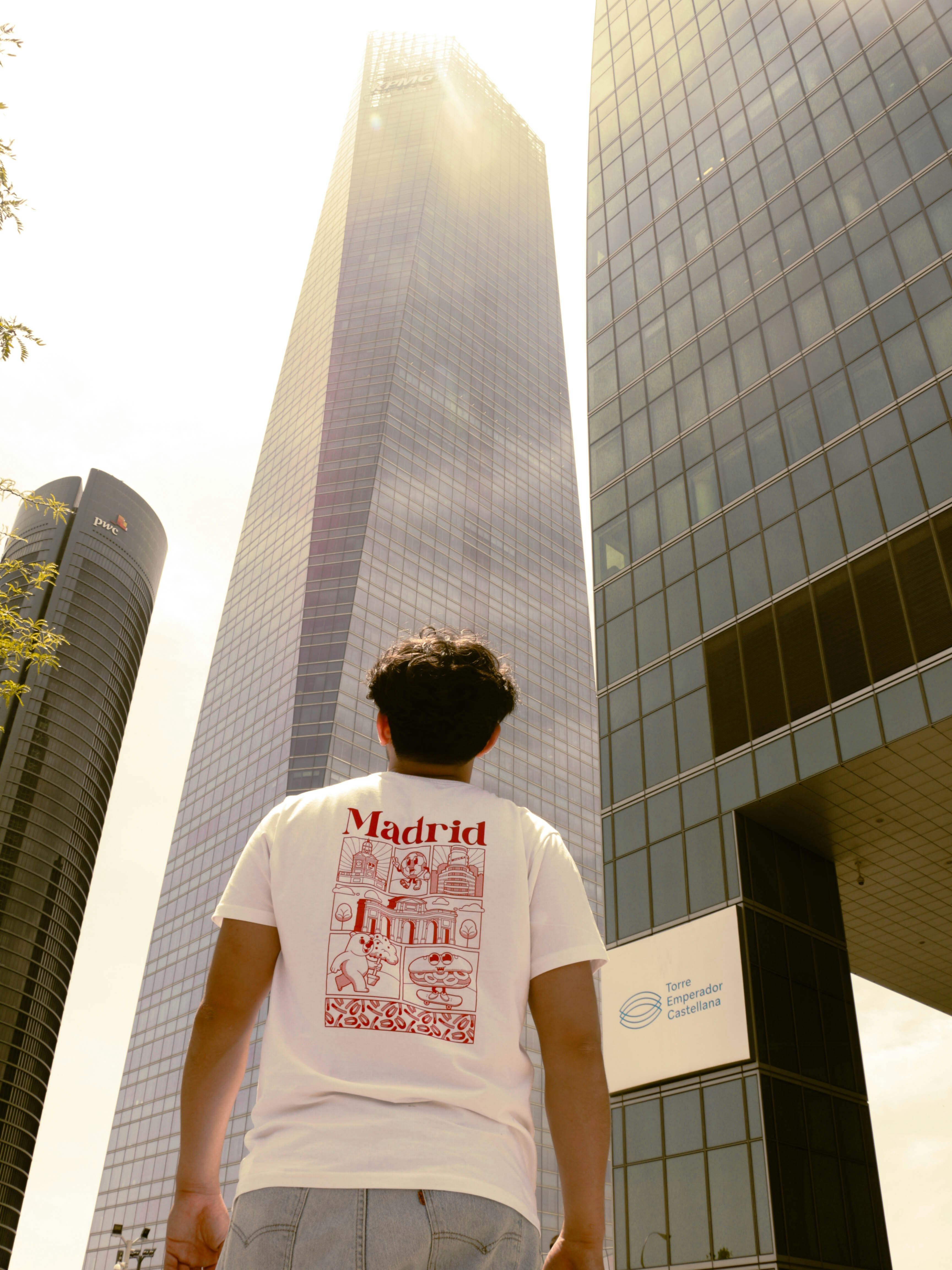 Urban ascent: a lone figure foregrounds a glass-towered skyline
