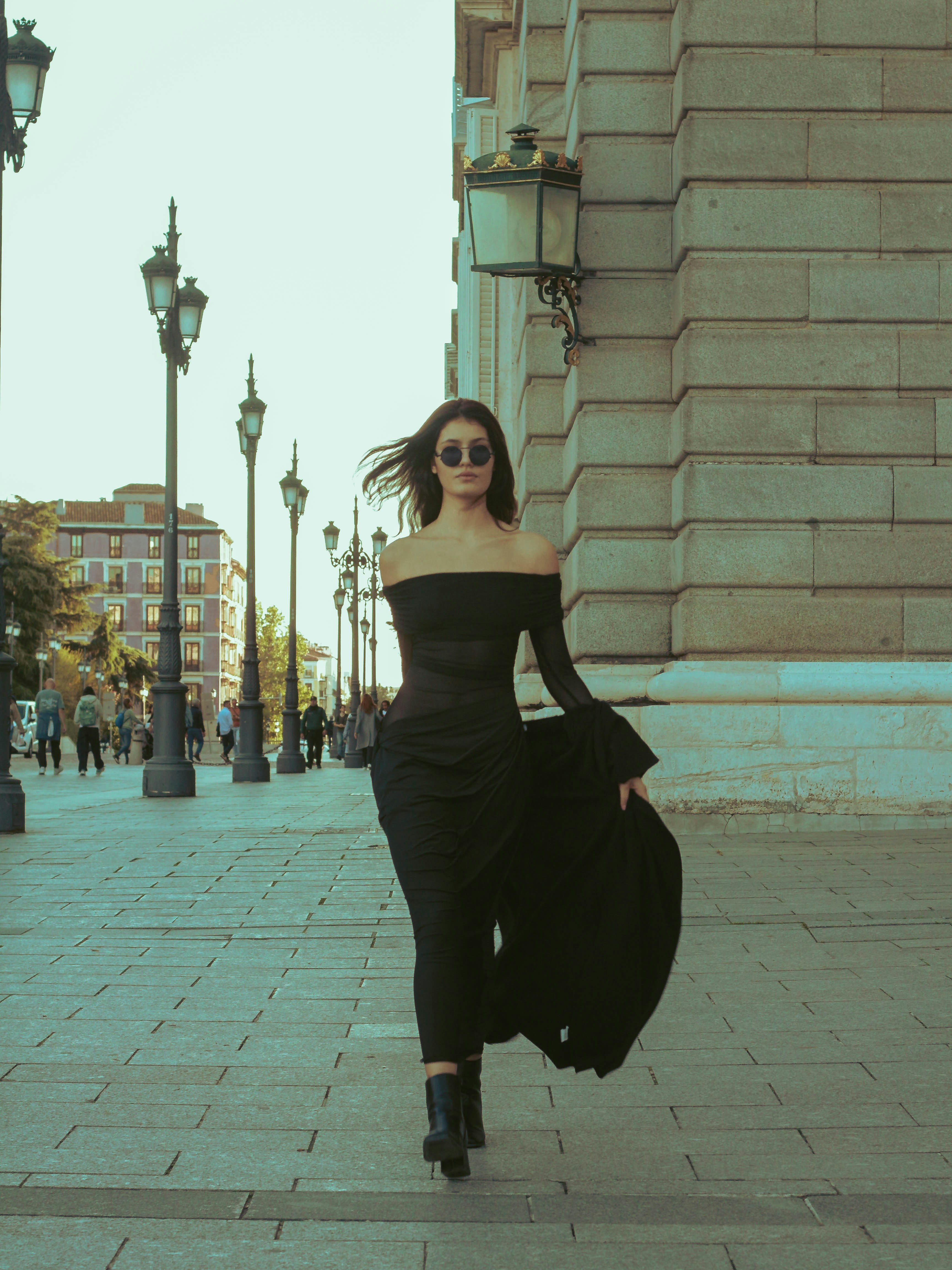 CityStreets in Black: A poised silhouette strides past grand arches