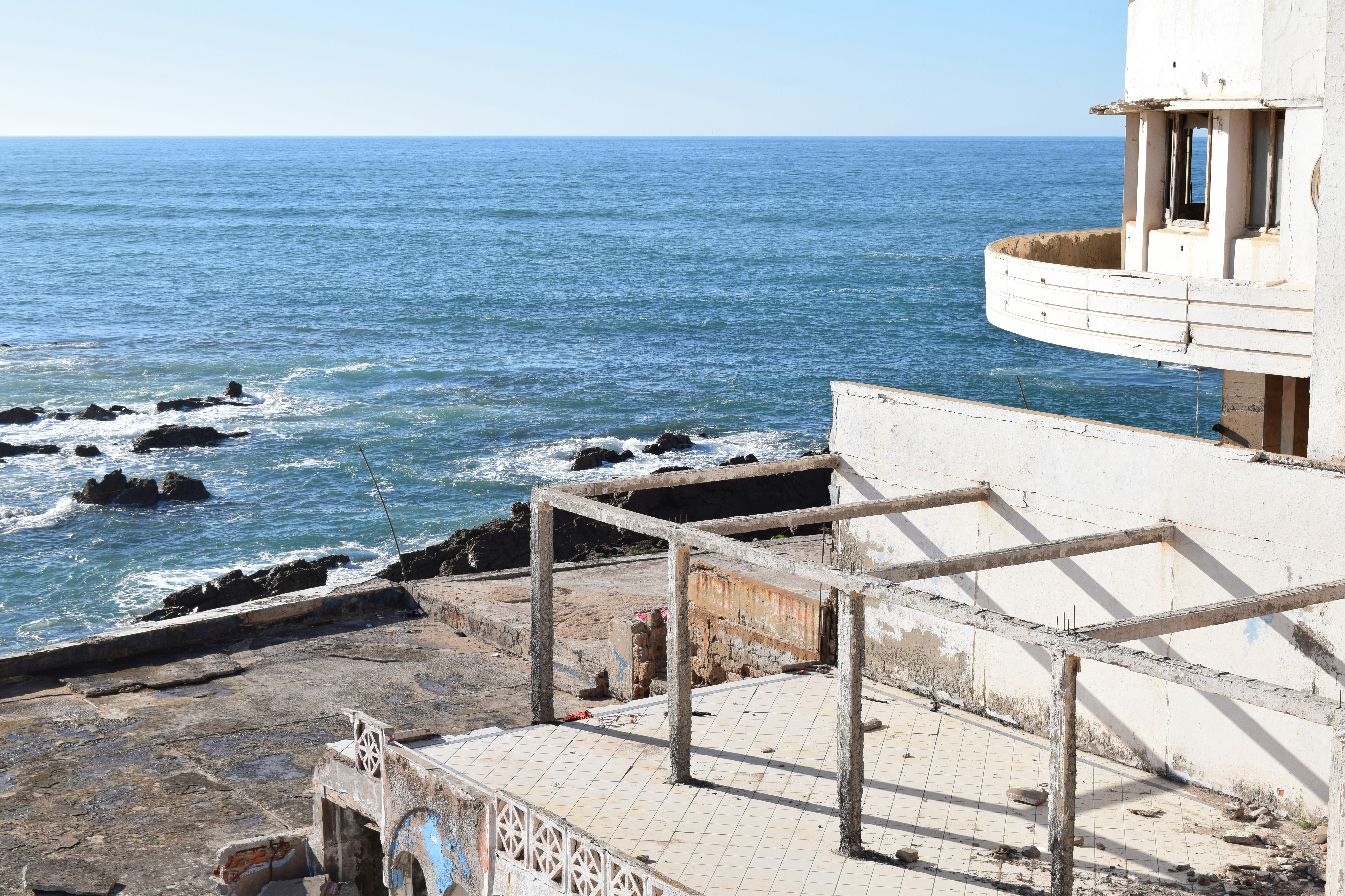 Abandoned Oceanfront Deck Reaching Toward the Distant Sea