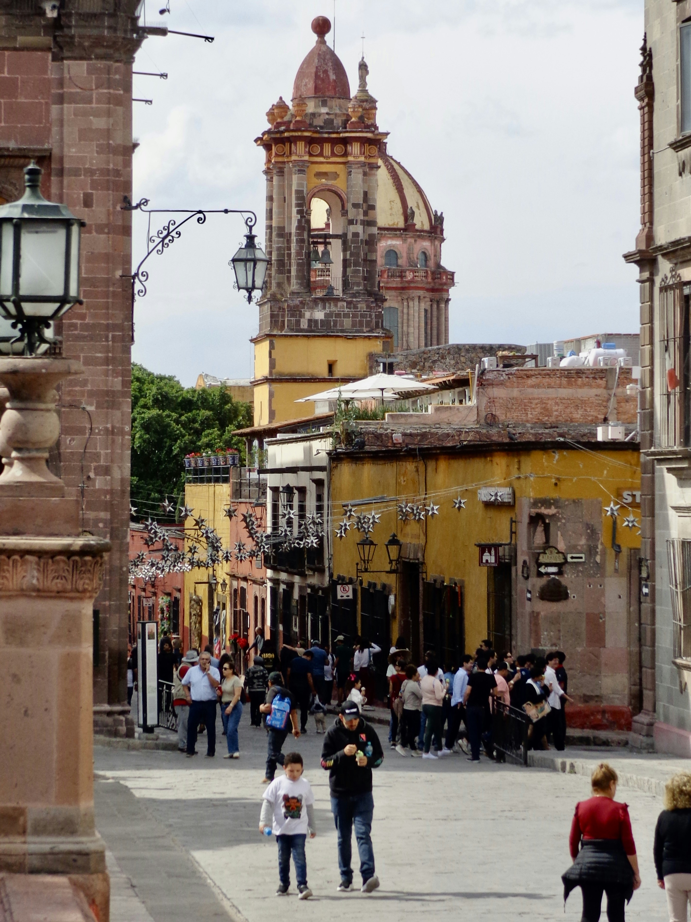 Colorful Callejon: A Sunlit Street in a Colonial Town Framed by a Dome-topped Bell Tower
