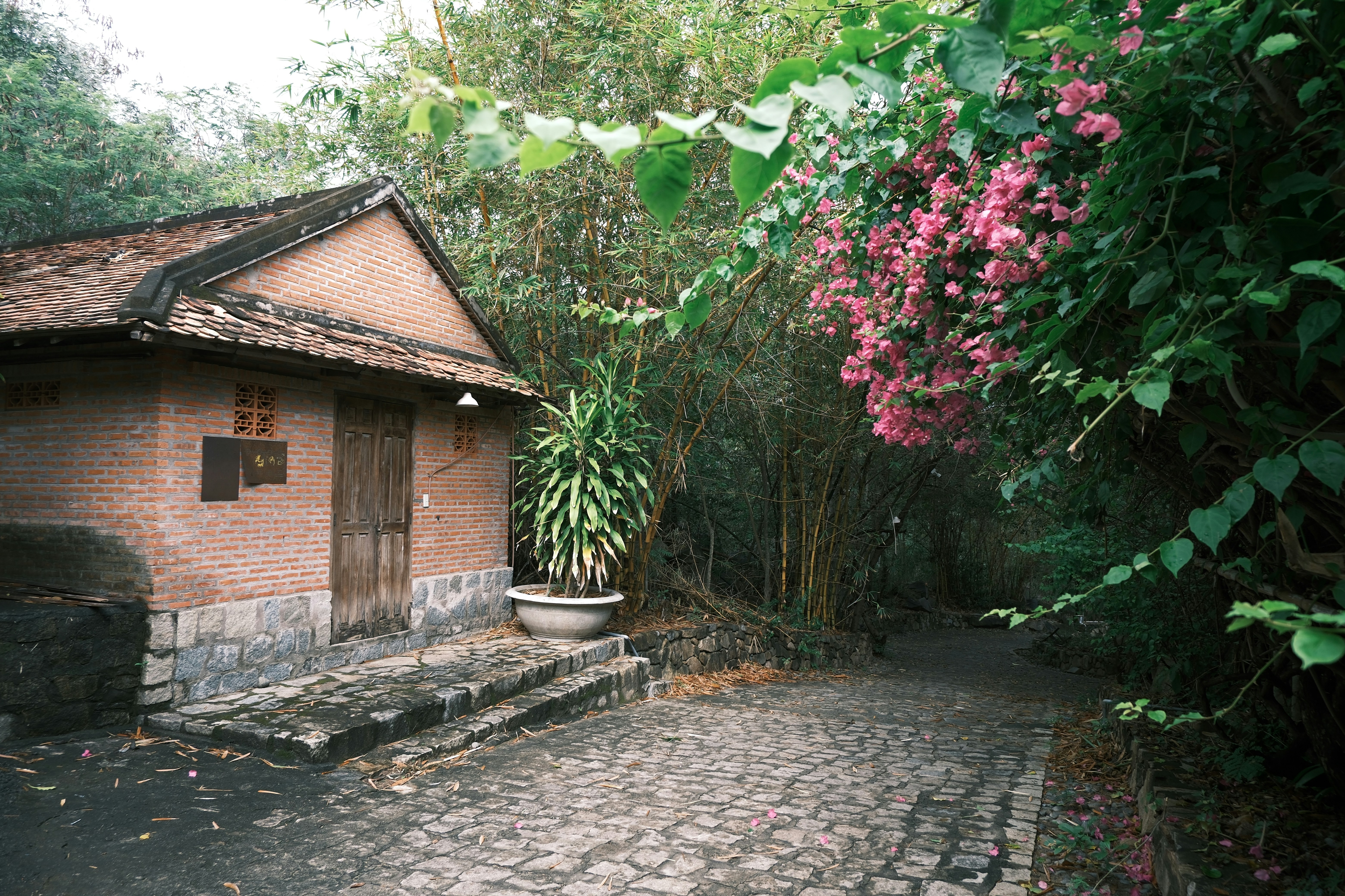 Brick Hut at the Edge of a Quiet Flowering Garden