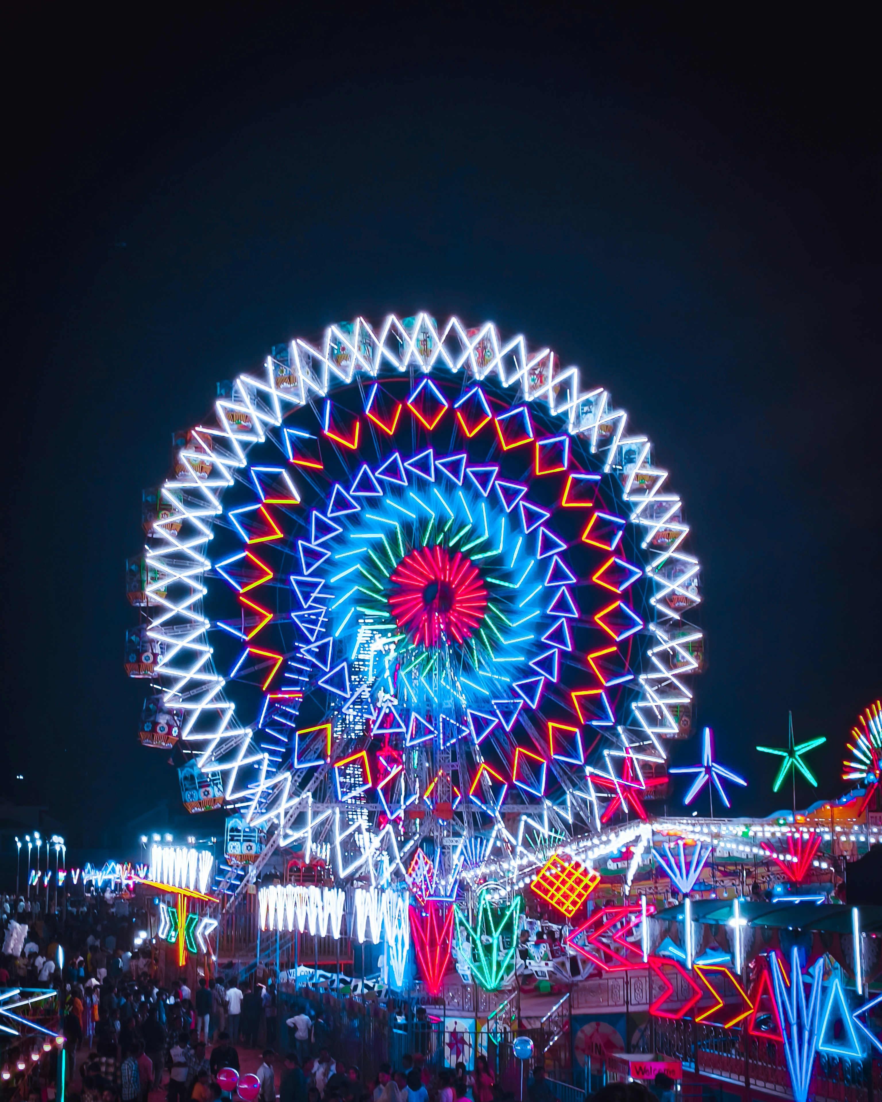 Neon Wheel of Night: A Carnival Light Spiral