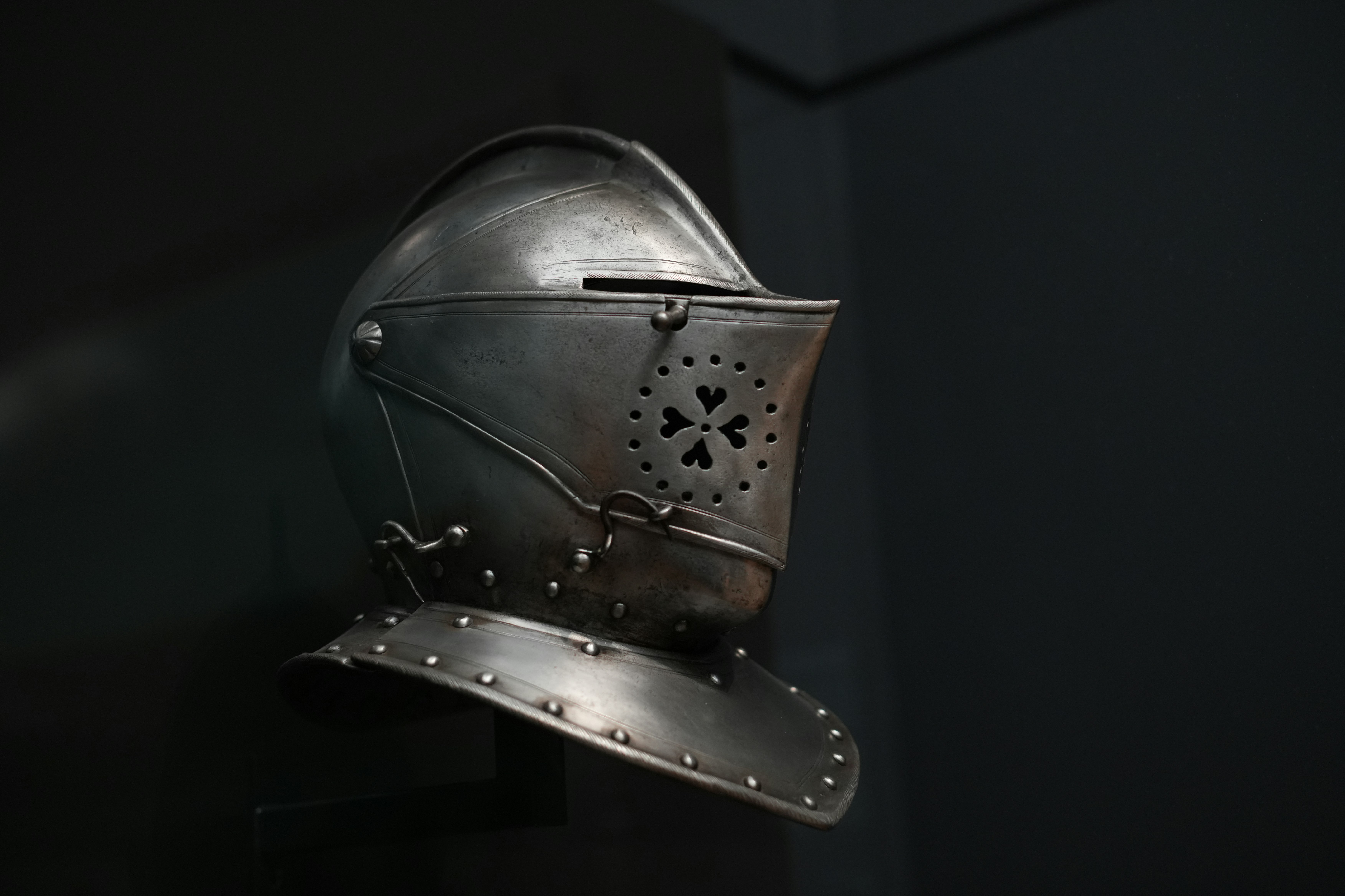 Iron Visage: A solitary knight's helm suspended in shadow