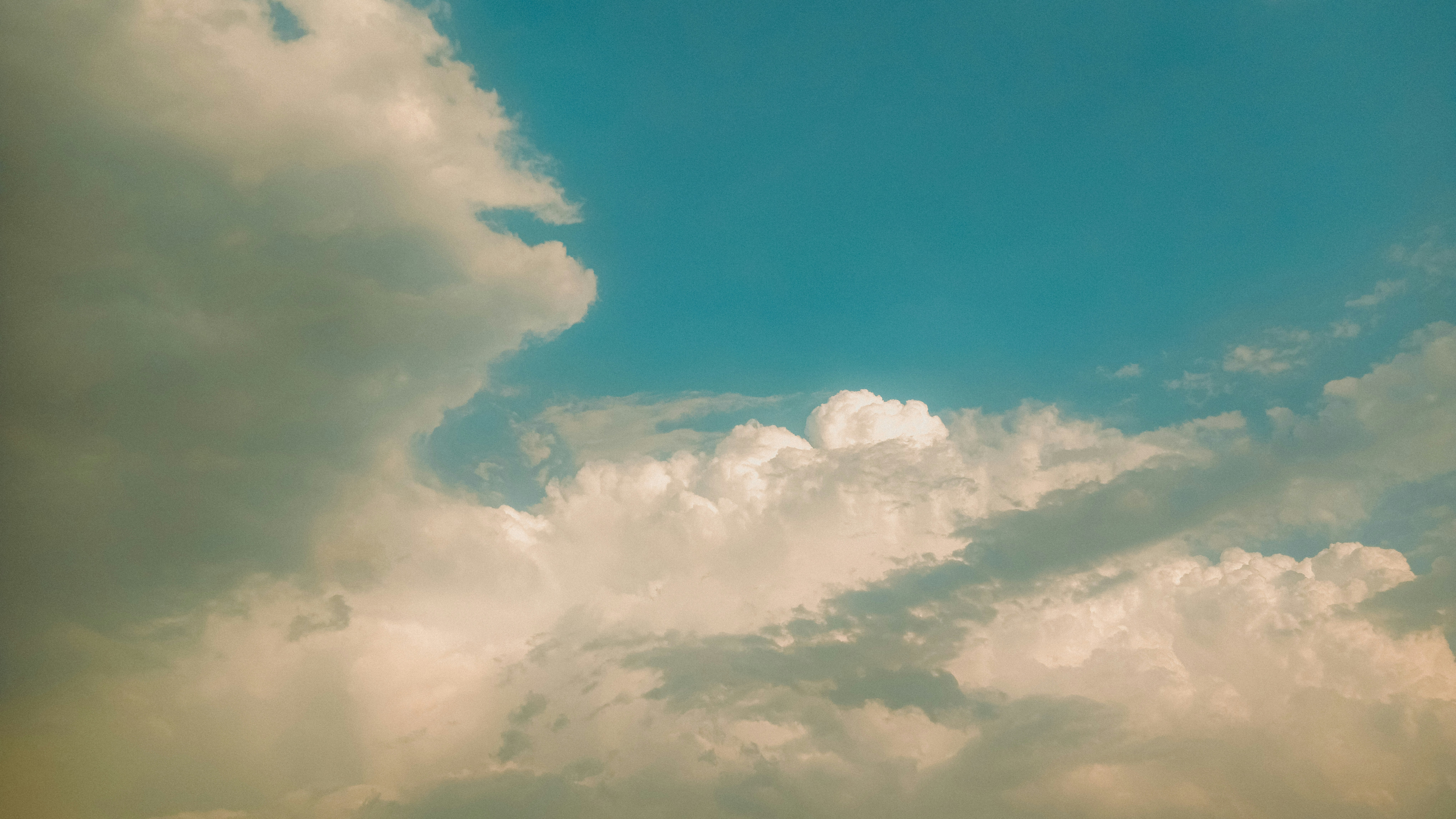 Bright Sky and billowing clouds over a calm horizon