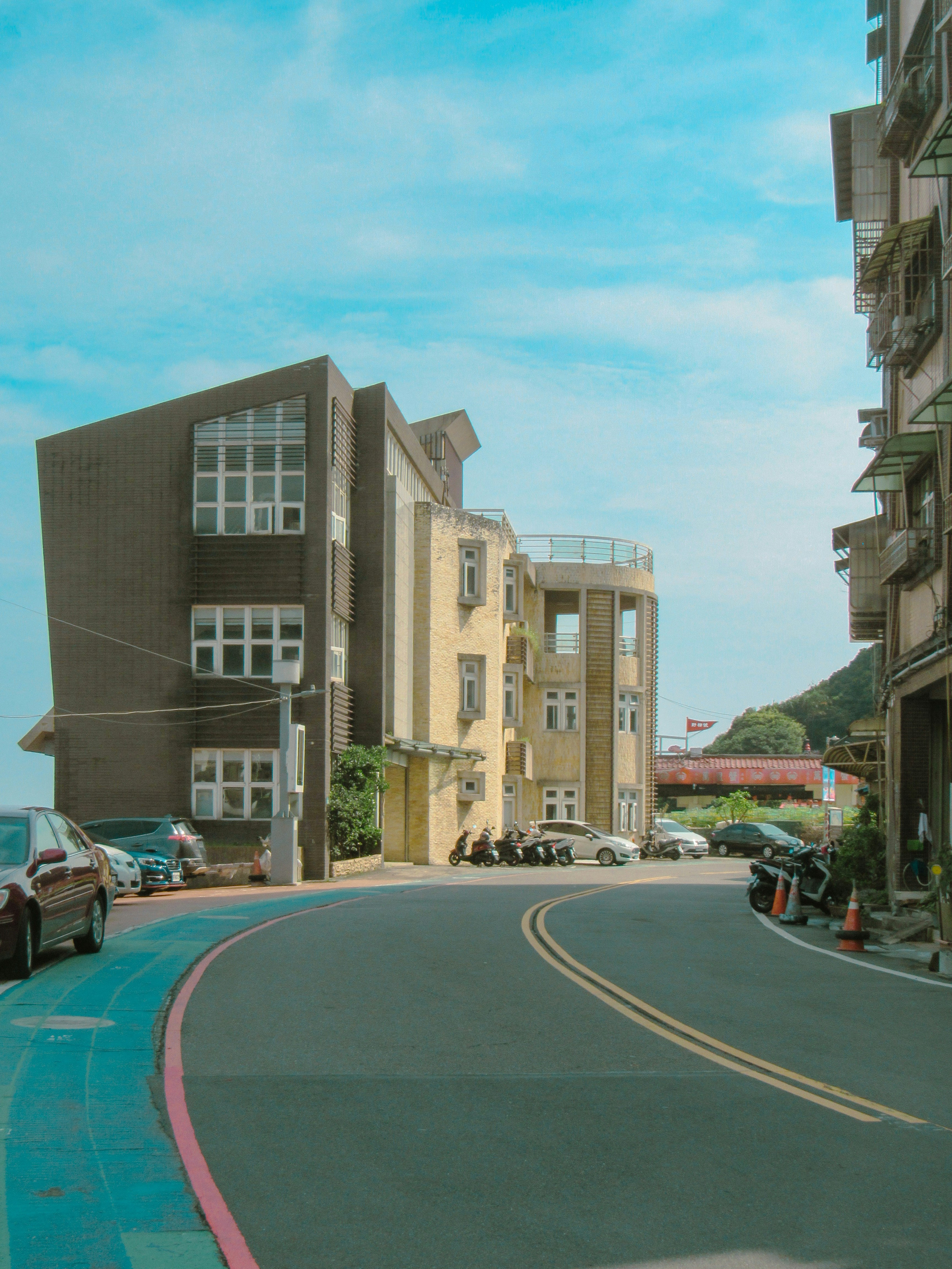 Curved City Street Framed by Modern Blocks on a Bright Day