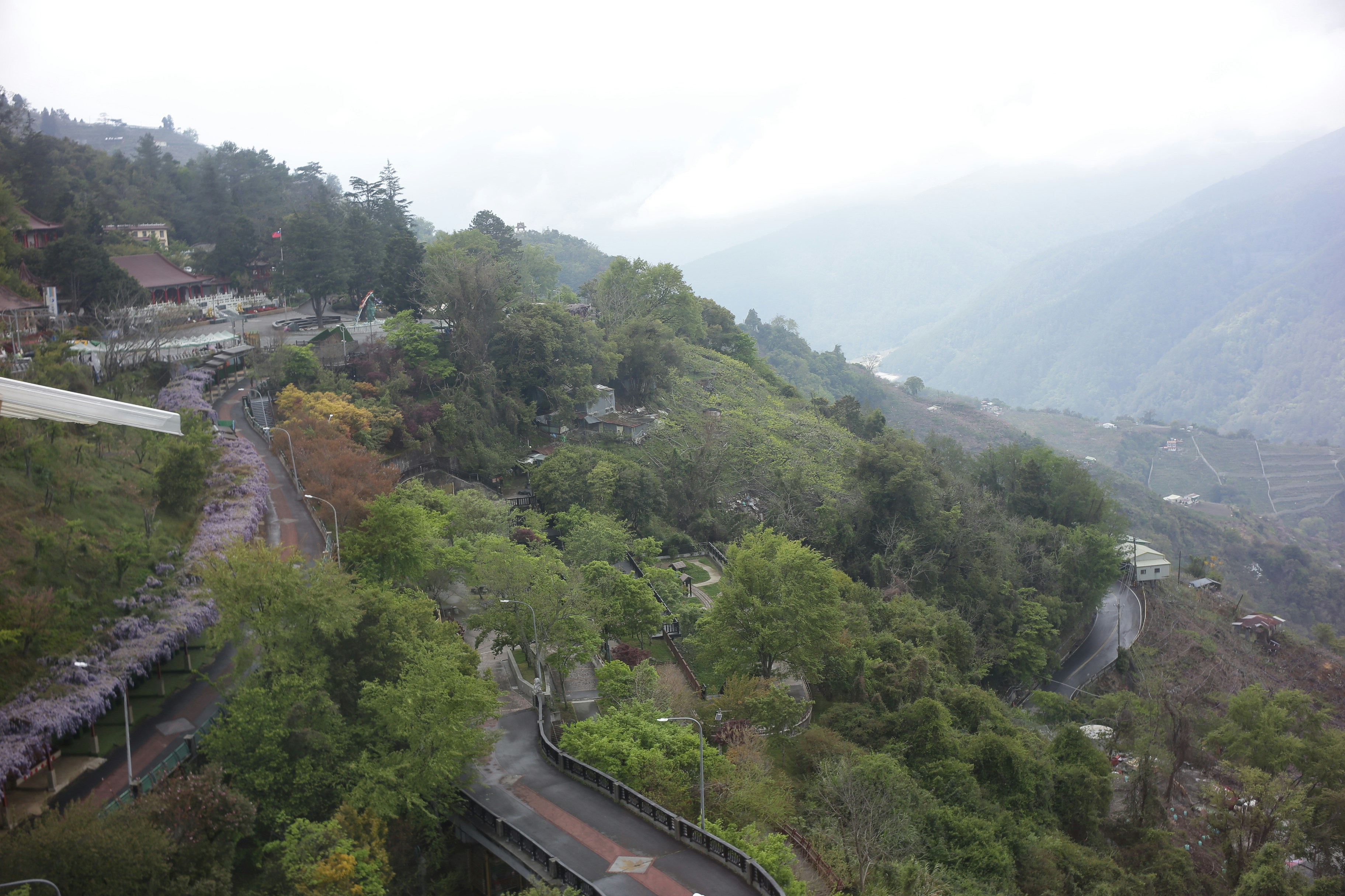 Terraced hillside overlook under a veiled mountain canopy