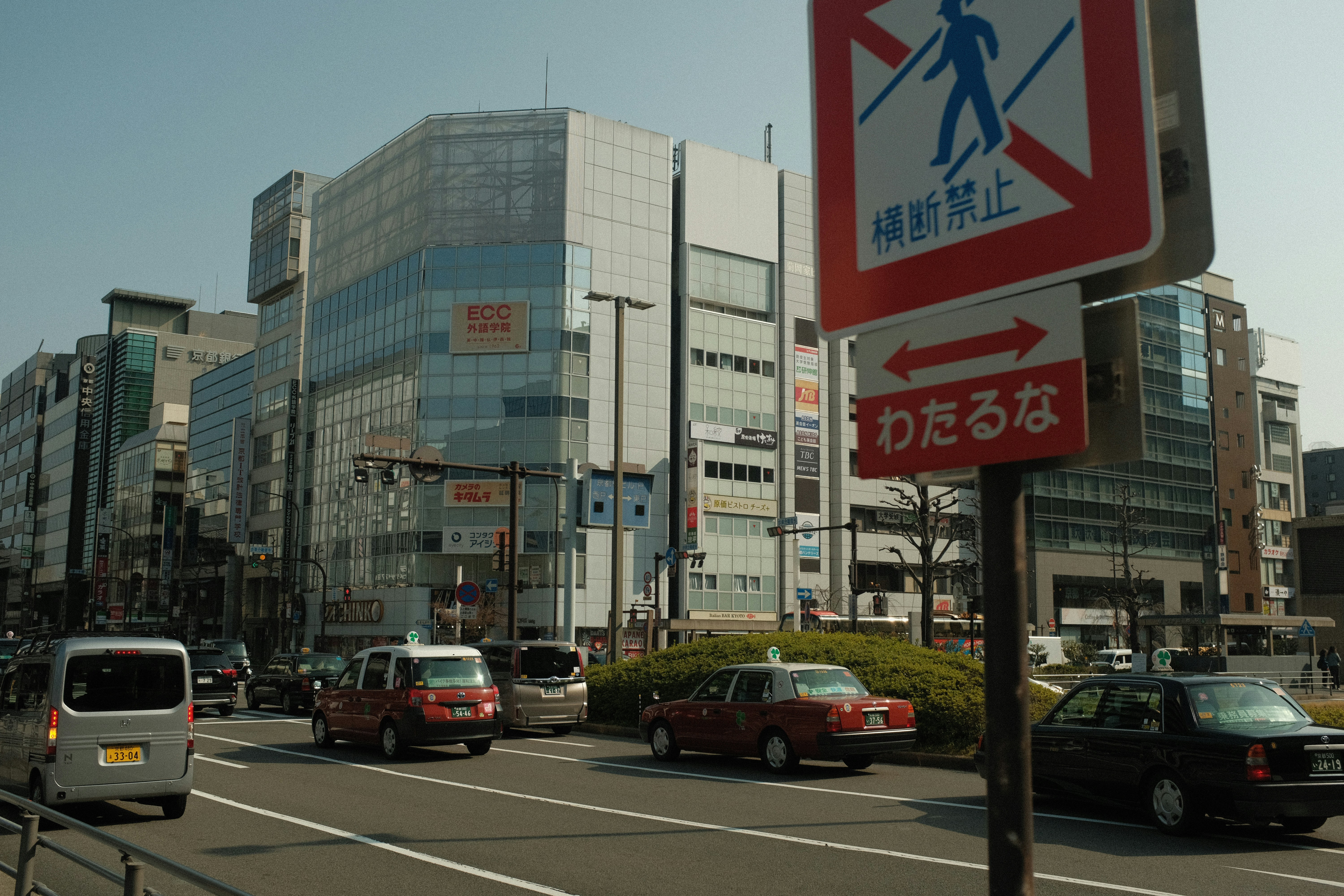 Crossroad Signal: Urban Street Activity Beneath Modern Glass