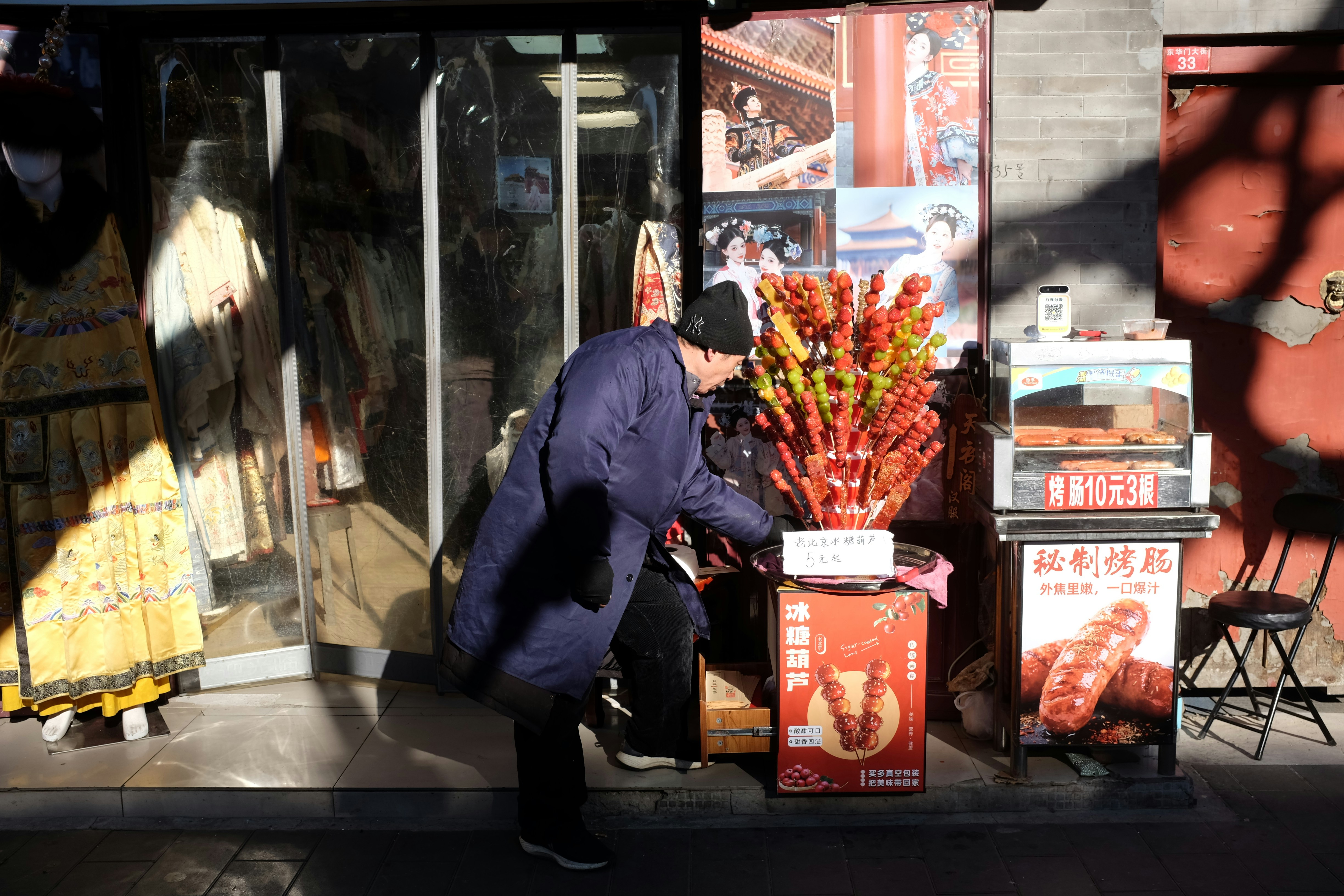 Street Vendor Under a Shadowed Shopfront