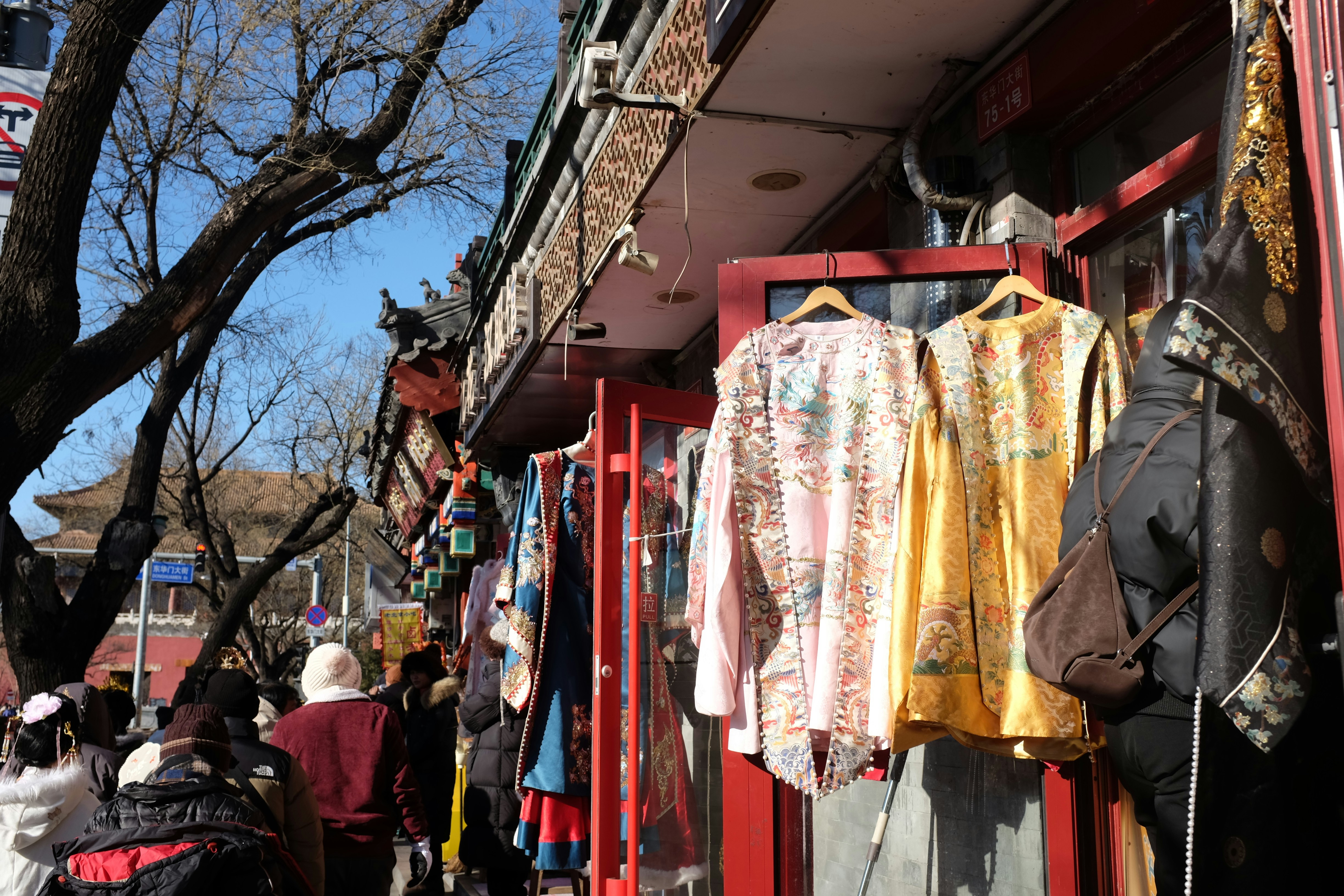 Colorful Garment Stalls Along a Sunlit Urban Street